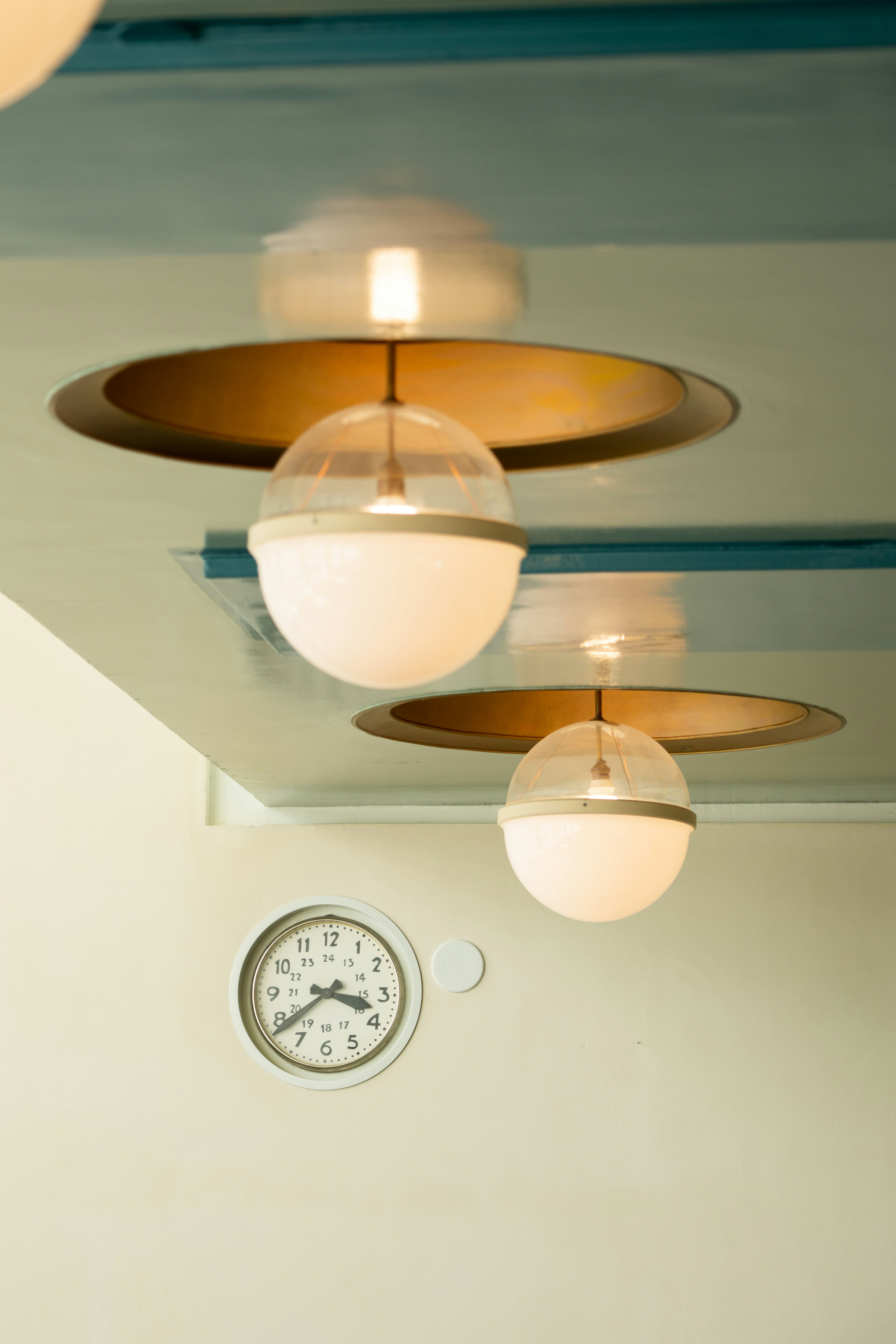 Mid-Century Ceiling Lights Reflect in a Quiet Room