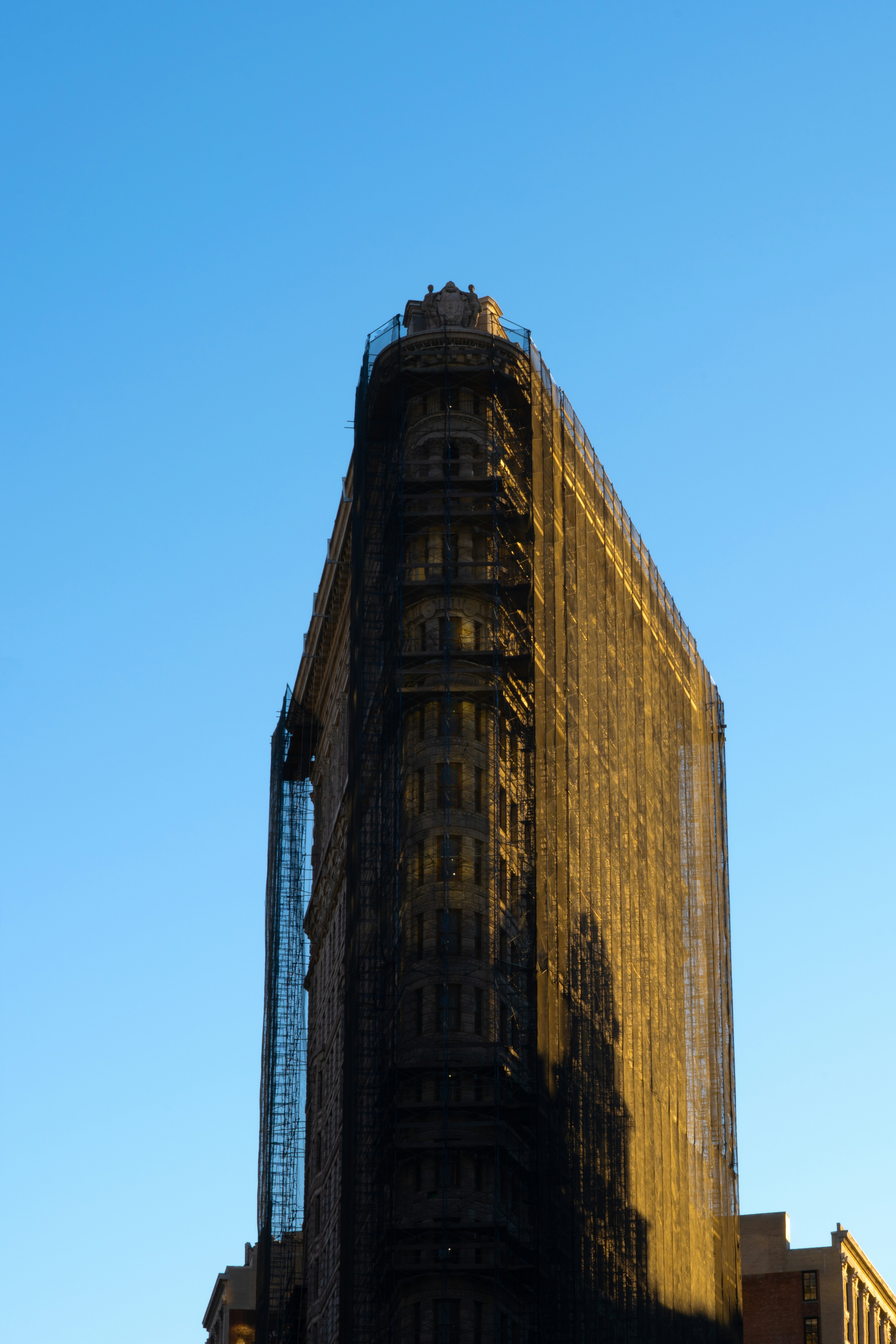 Sunlit Facade: A Towered Classic Bathed in Evening Blue