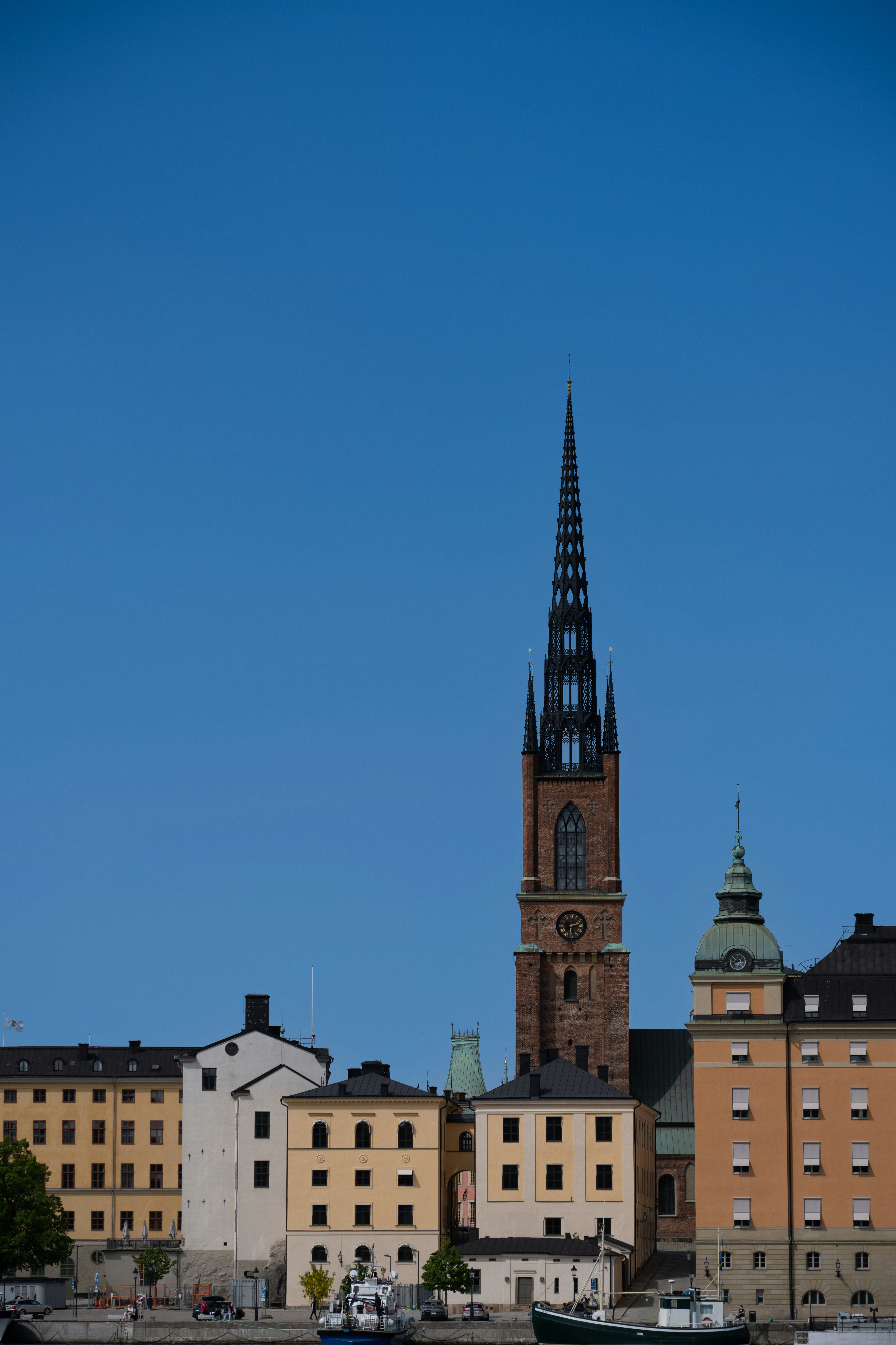 Spire and cityscape under a clear blue sky