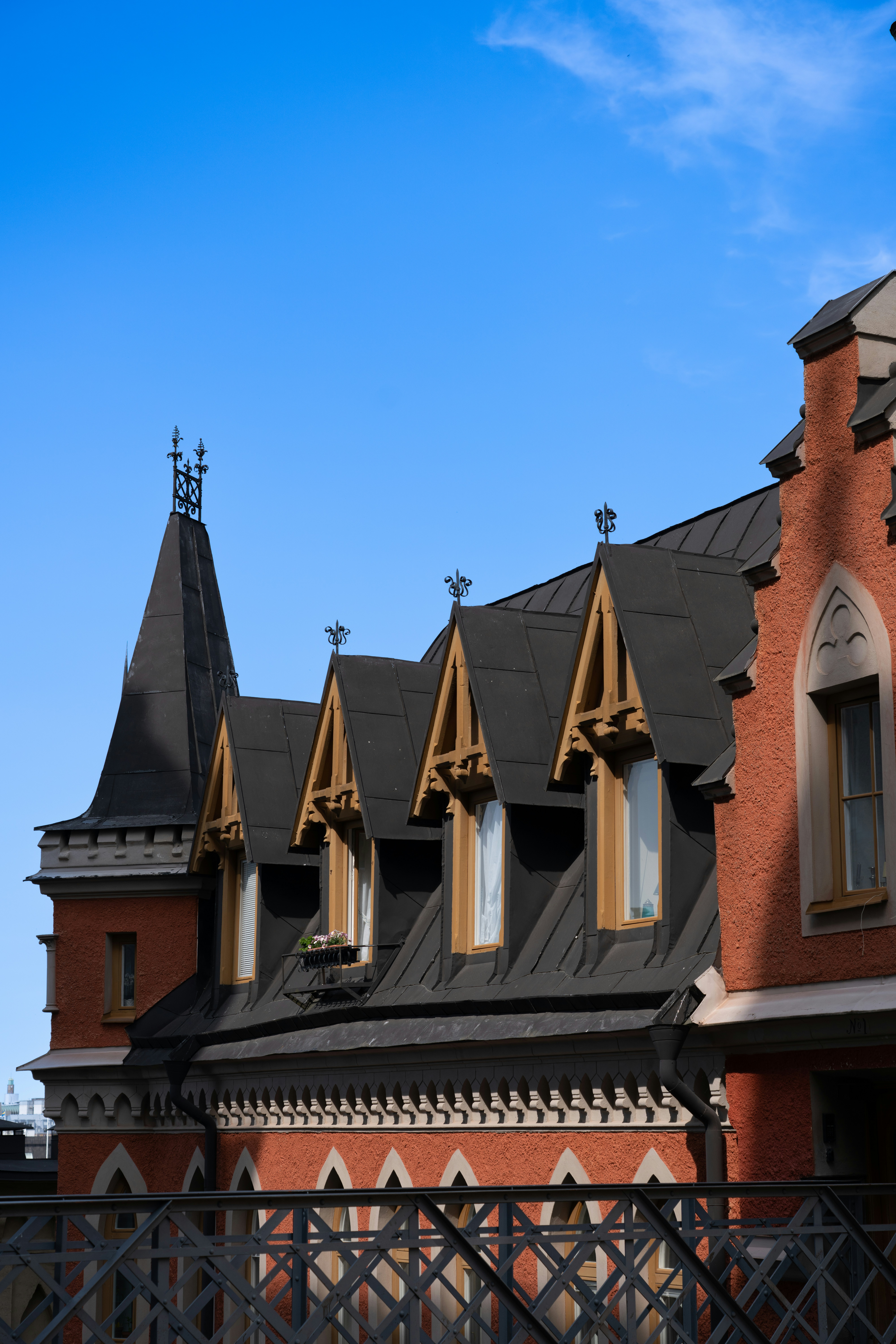 Architectural Peaks: A Row of Steep Gables Against a Clear Blue Sky