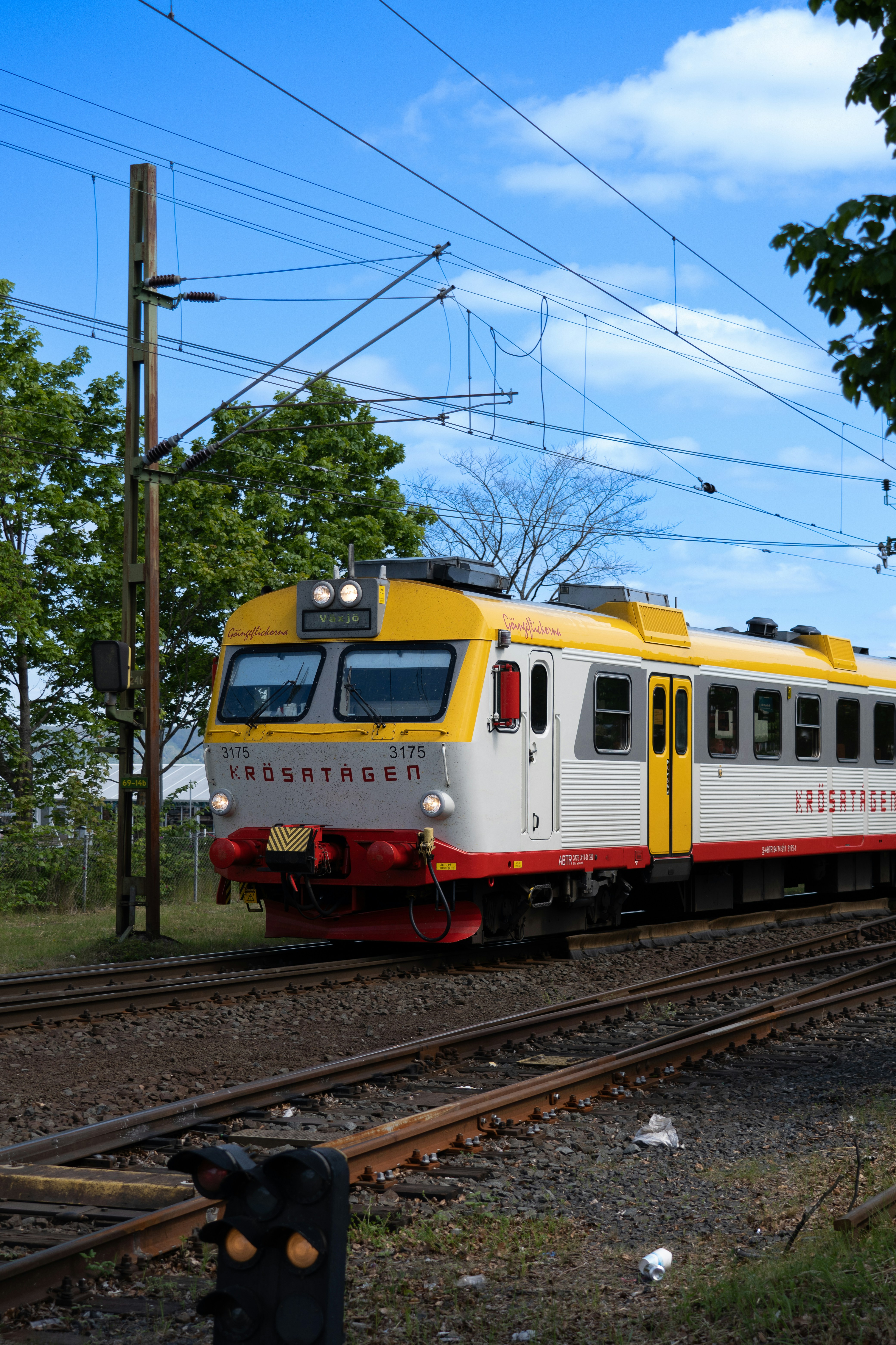 Yellow-Trimmed Commuter on the Rails: A Moment from the Tracks