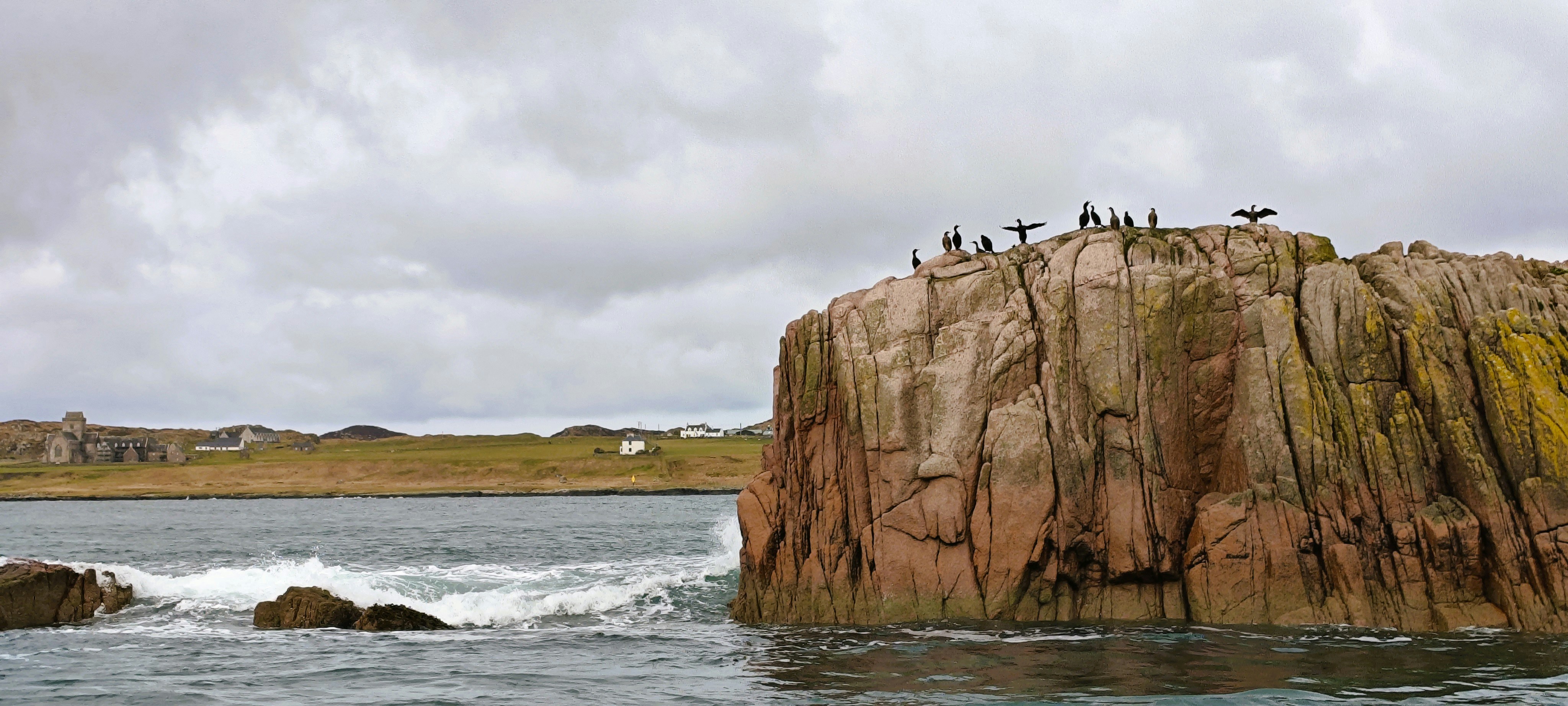 Sea Cliff Silhouettes: People on a Rugged Topped Outcrop