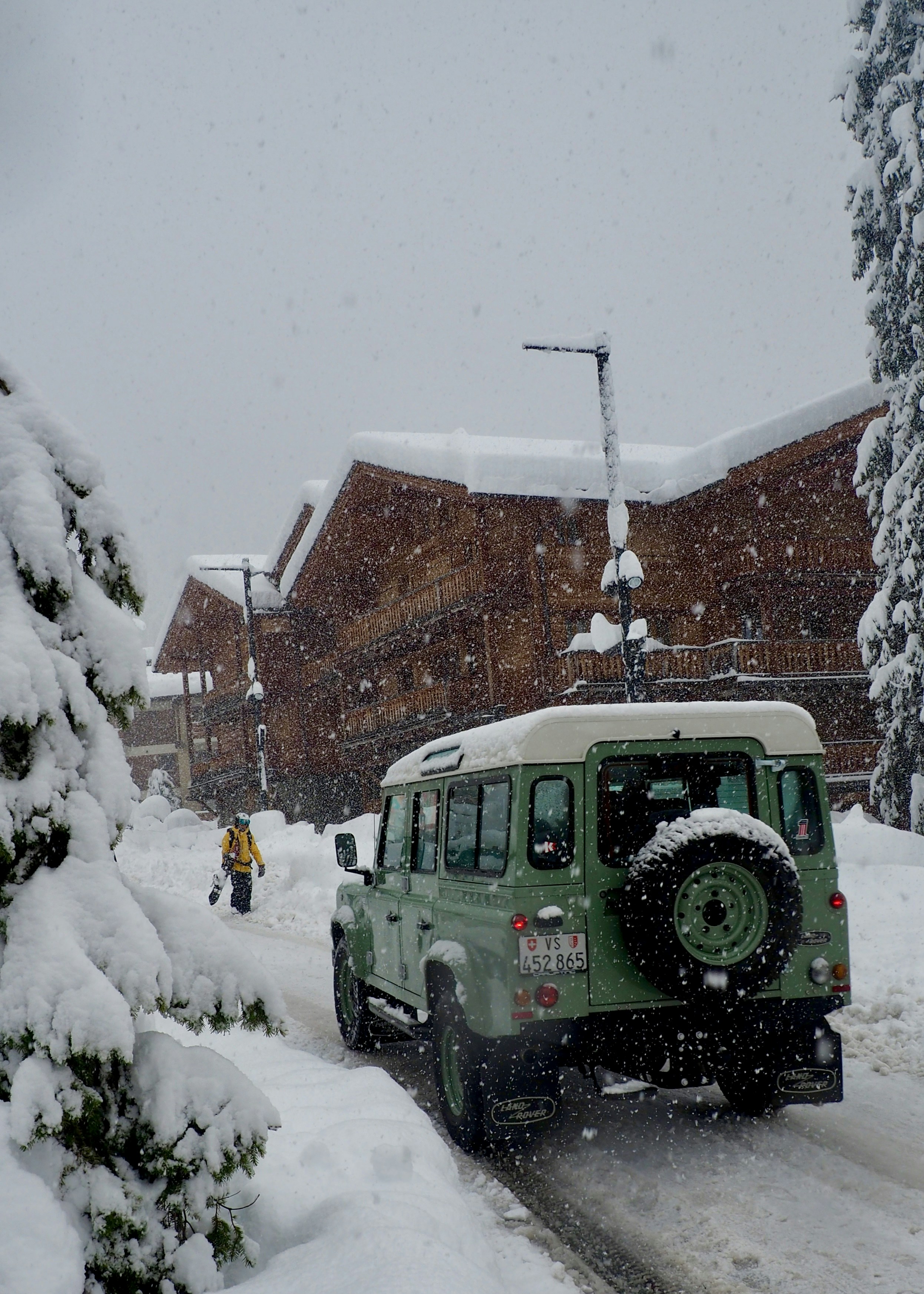 Green SUV in Snowy Alpine Village