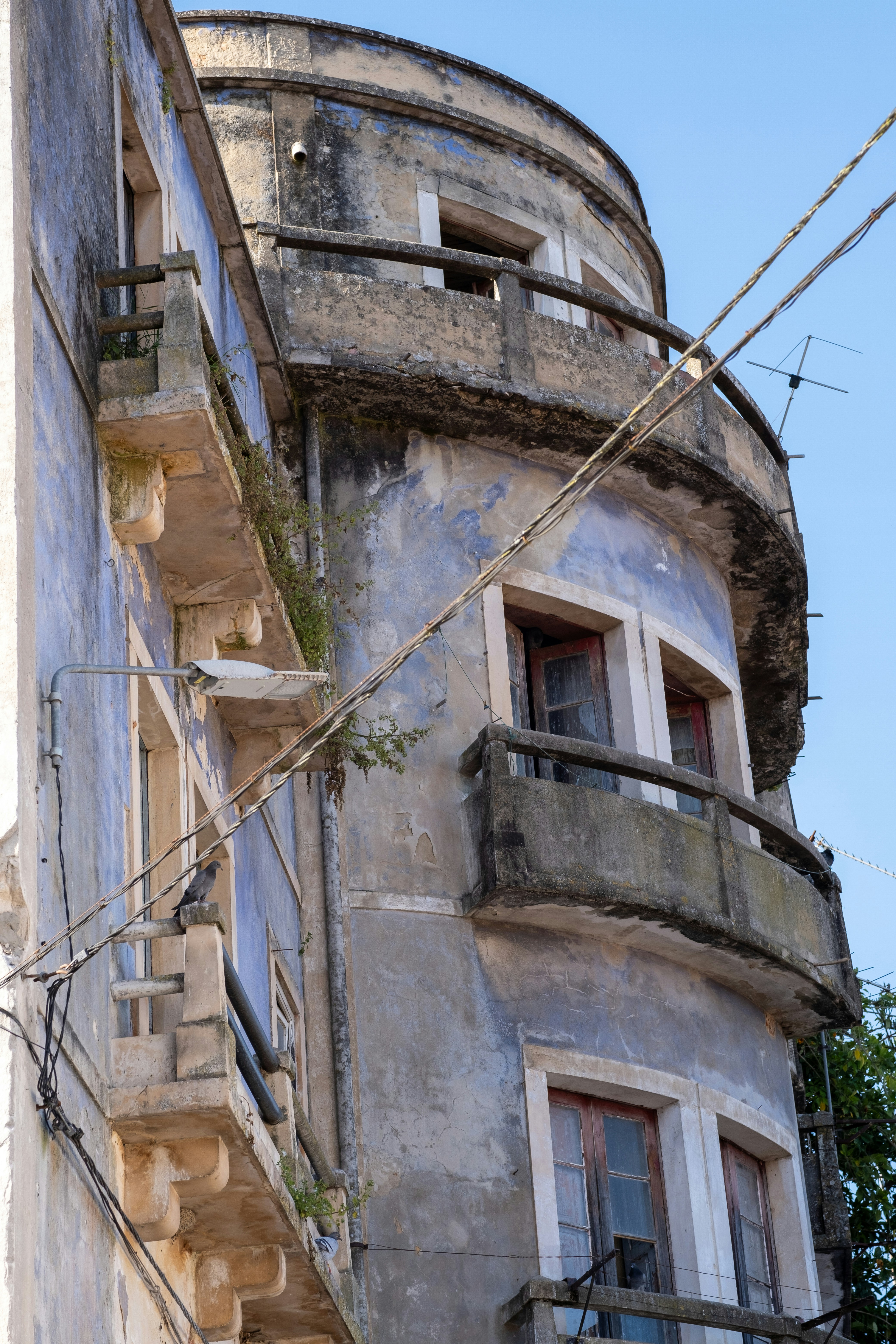 Weathered Turreted Facade: A peeling blue memoir of a coastal building