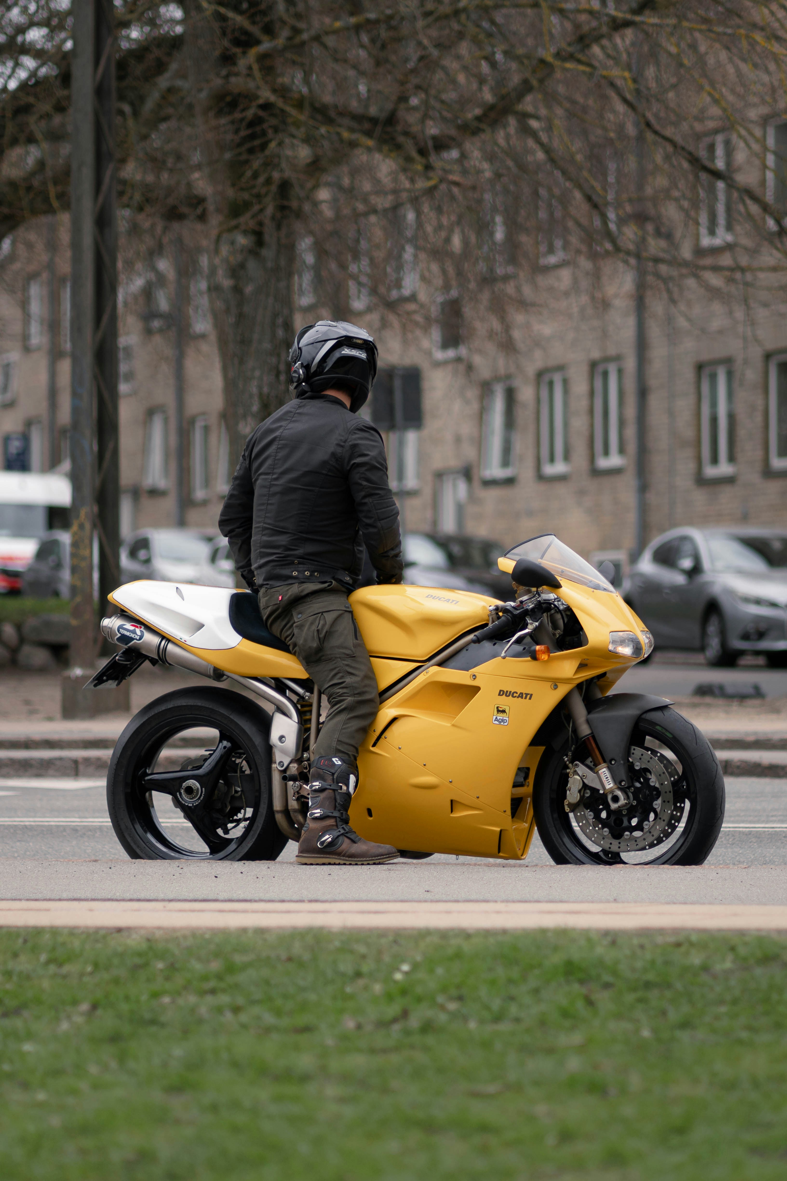 Yellow Ducati Stance: Rider Ready on a Quiet City Street