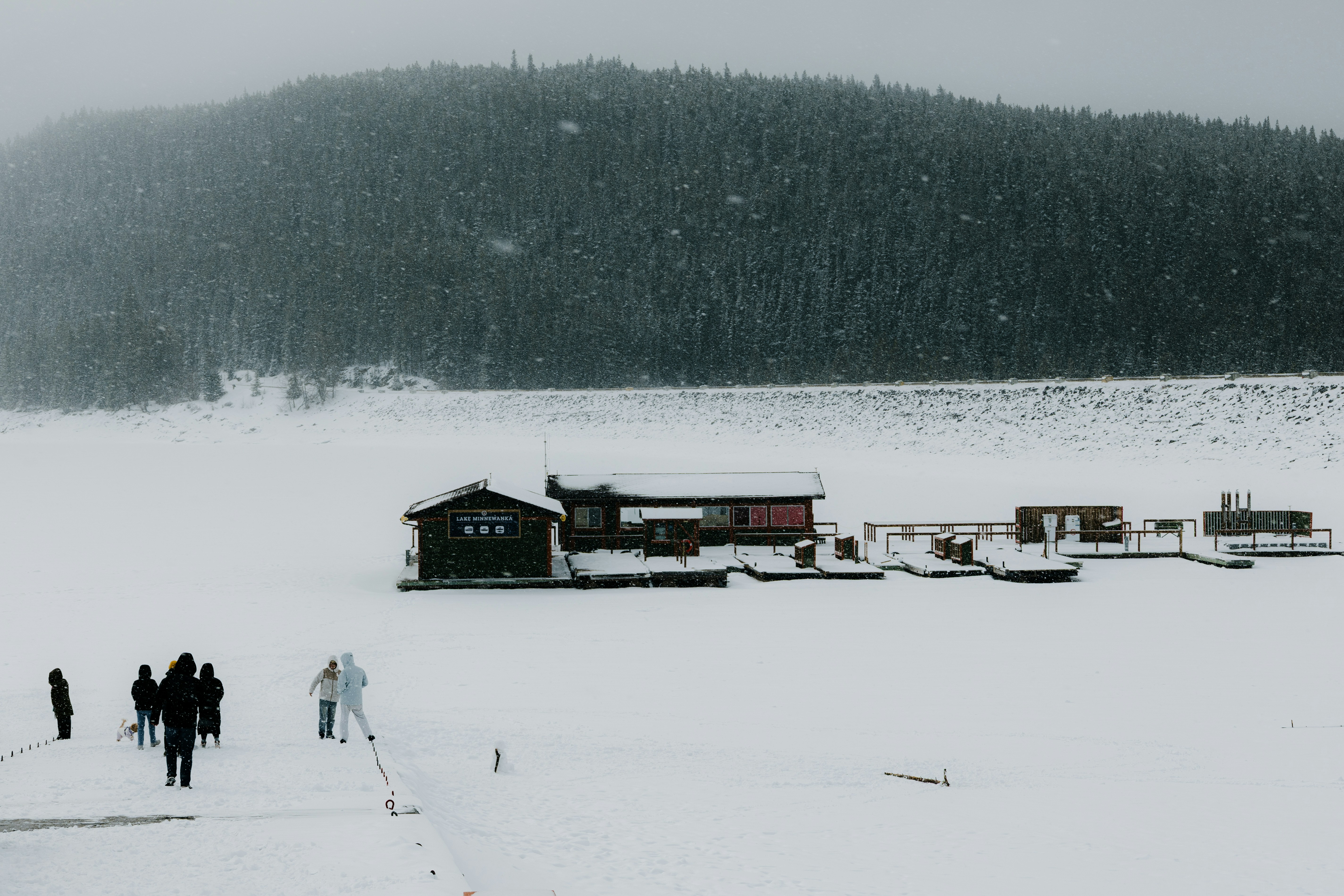 Snowy landscape with houses on frozen lake