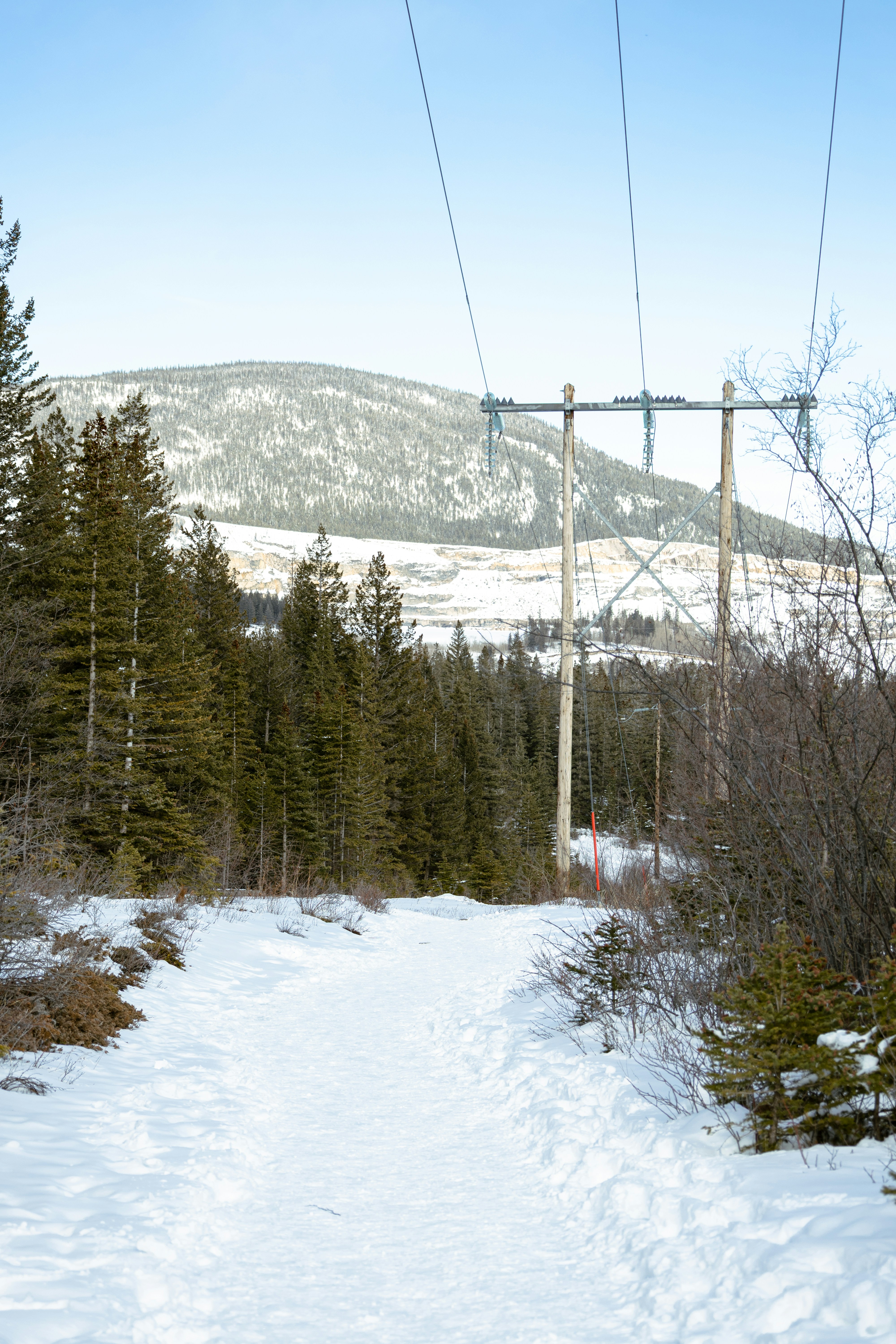 Cabled Crest: Snowy Ropeway Stretch Across Winter Valley