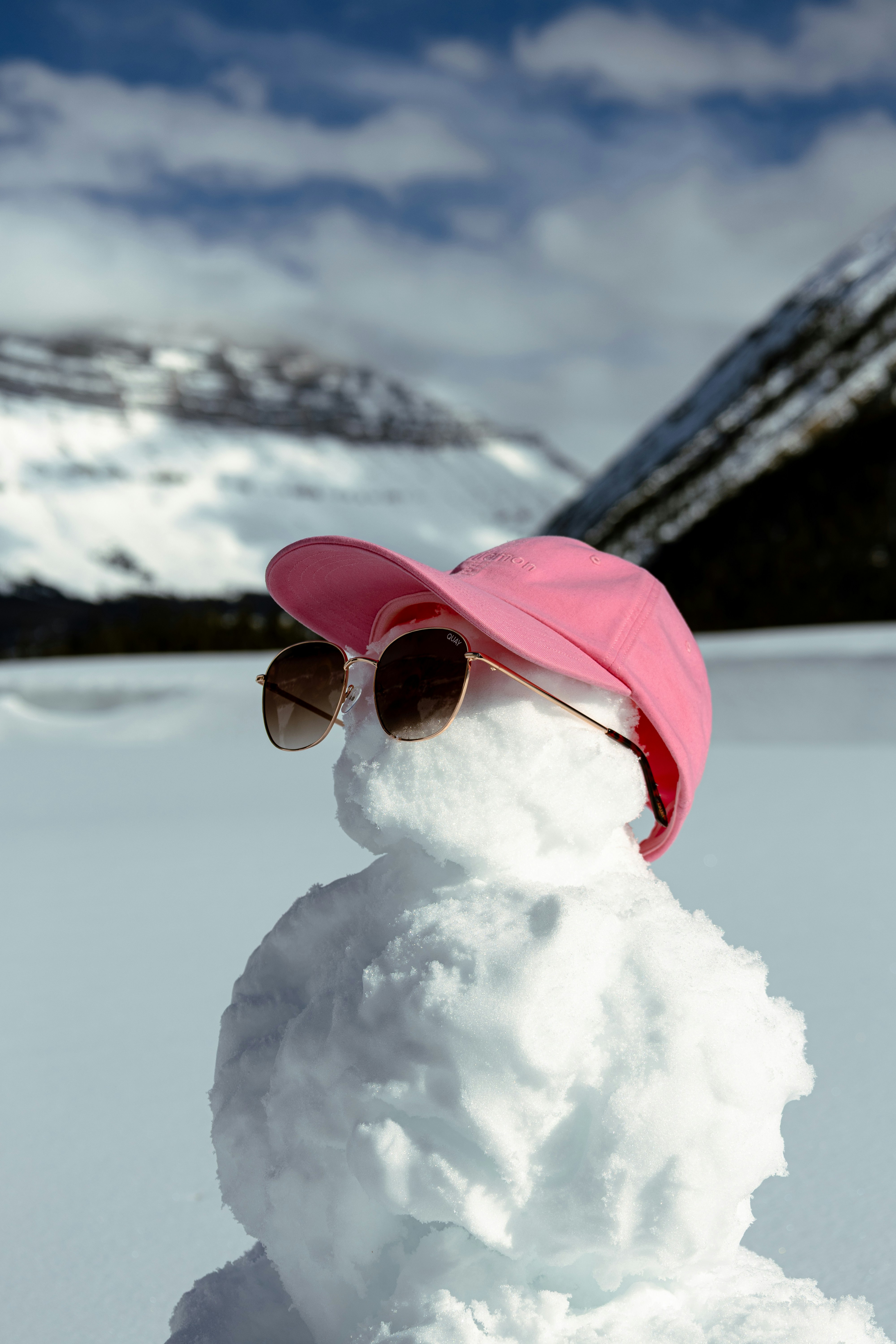 Pink Cap Snowman: A Curious Portrait amid Alpine Silence