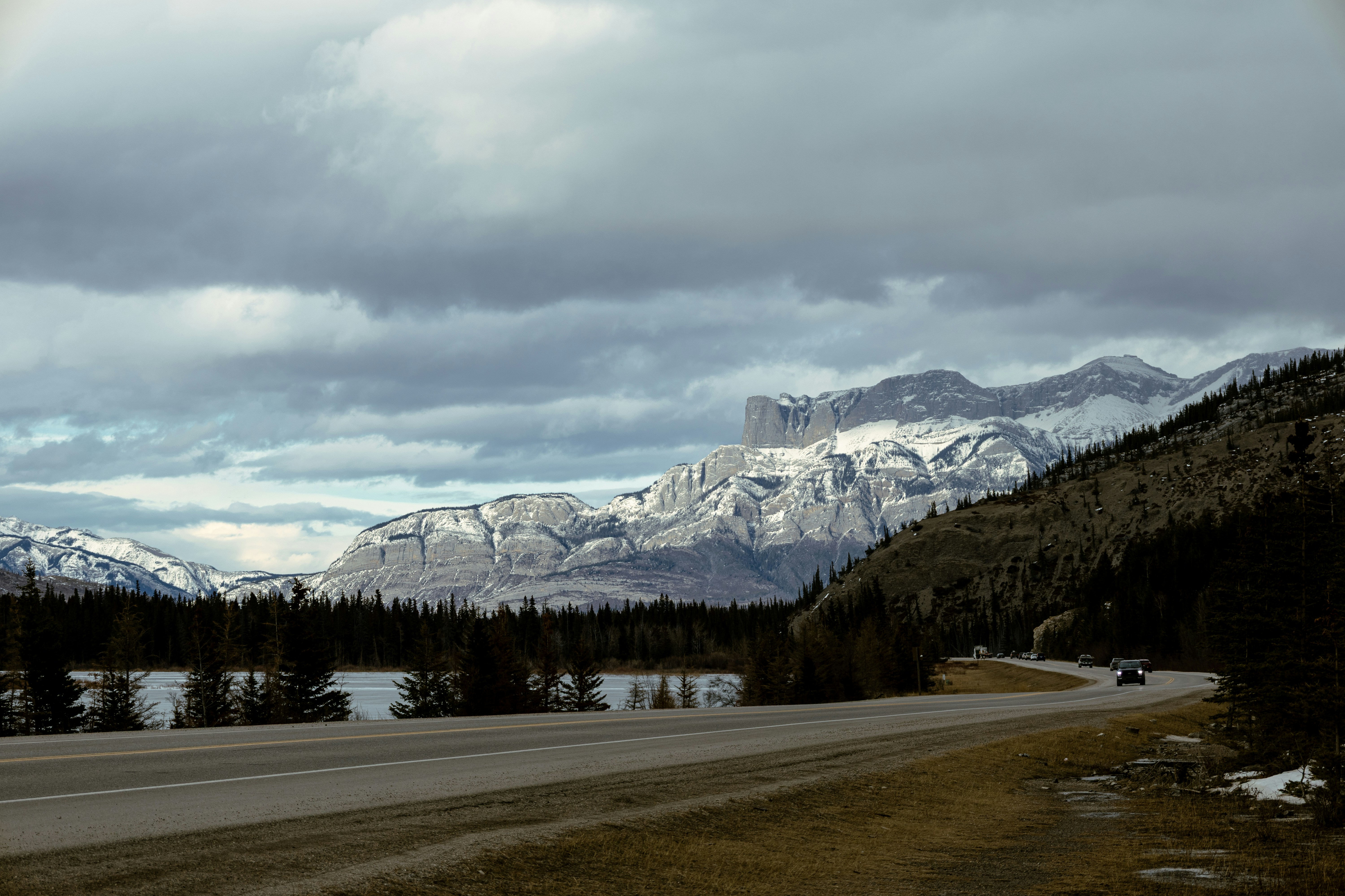 Snow-Dusted Peaks Framing a Quiet Mountain Road