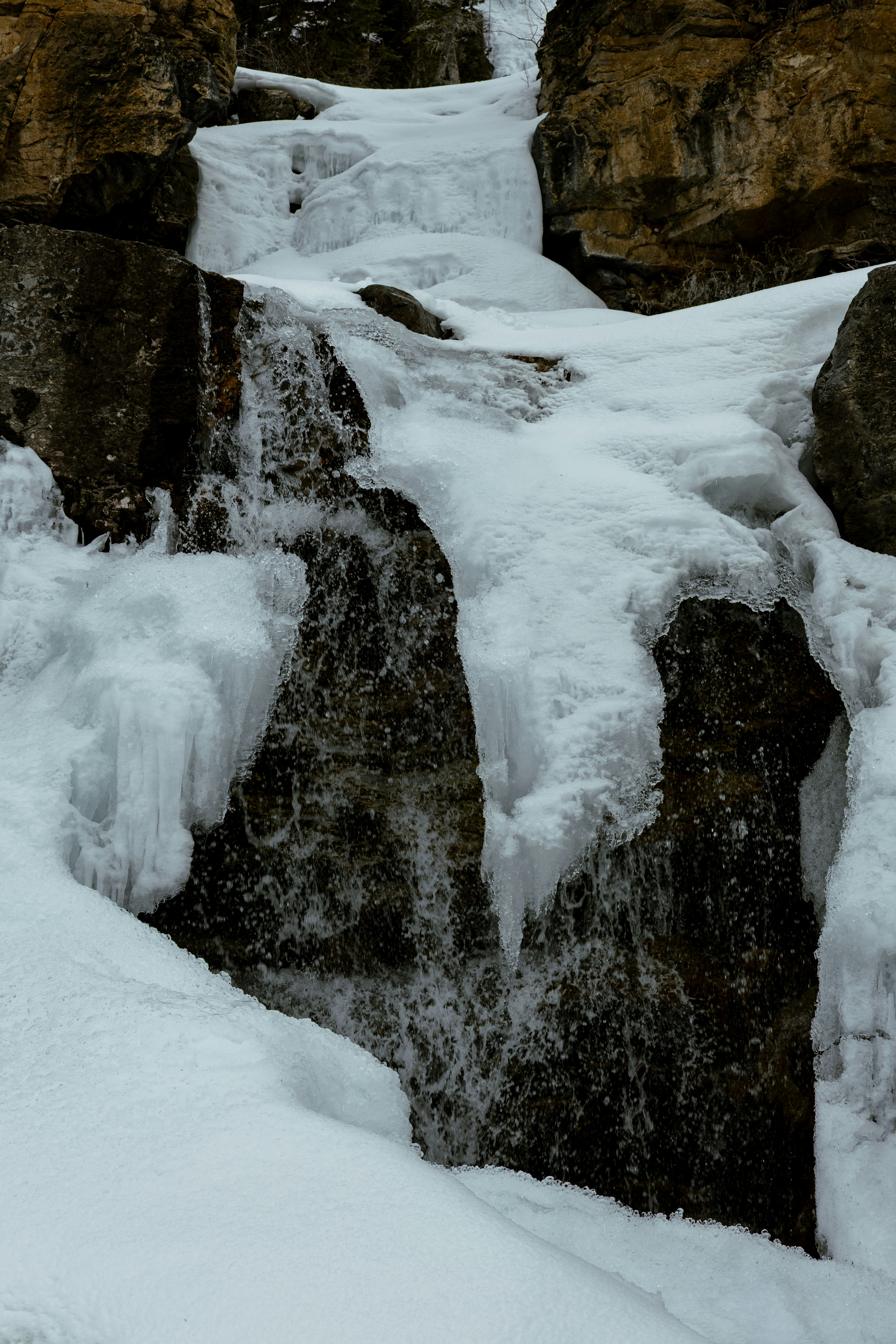 Snowbound Cascade: Ice-clad Rock Tiers in Quiet Descent
