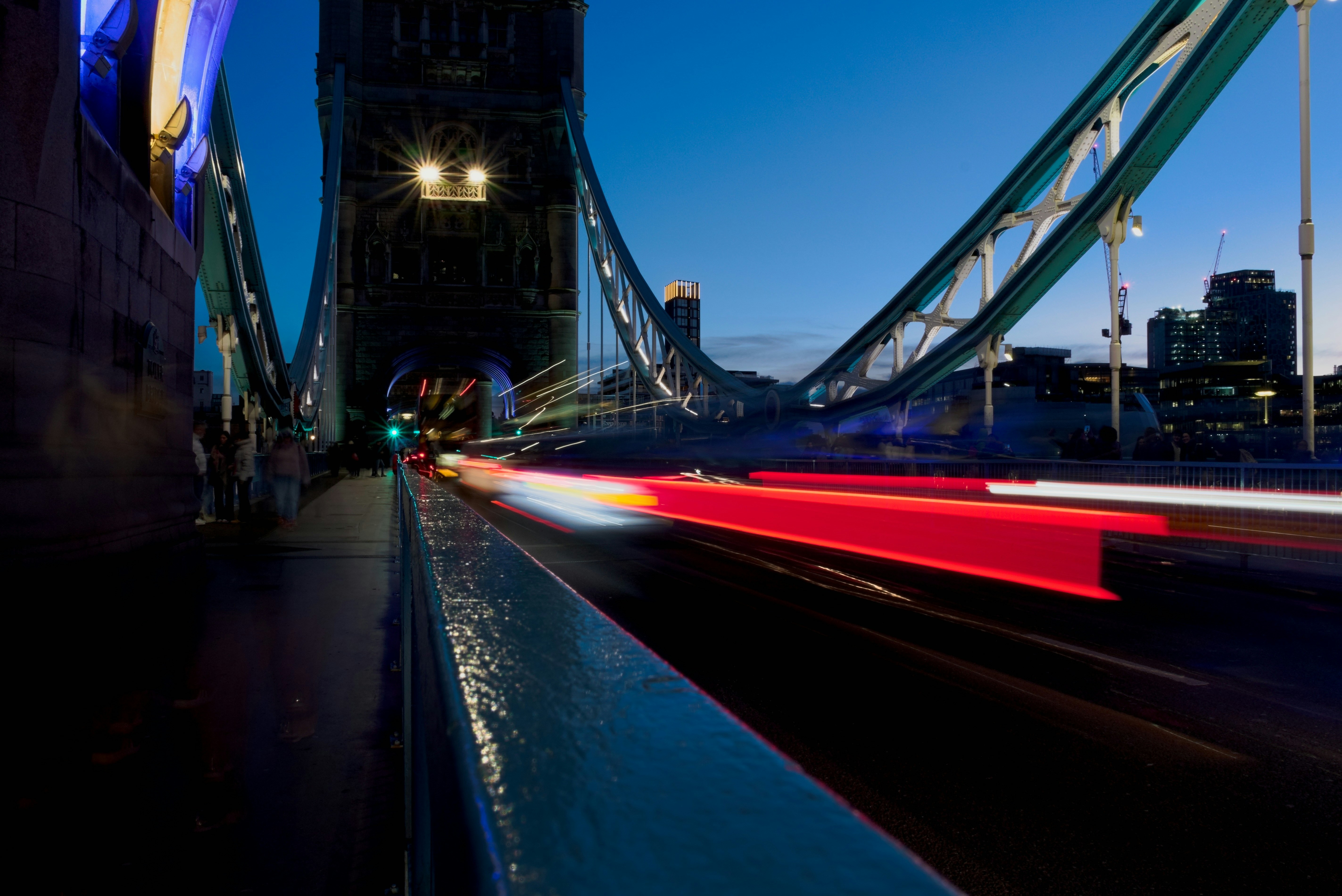 Gasps of Red Light on the Thames Bridge at Dusk