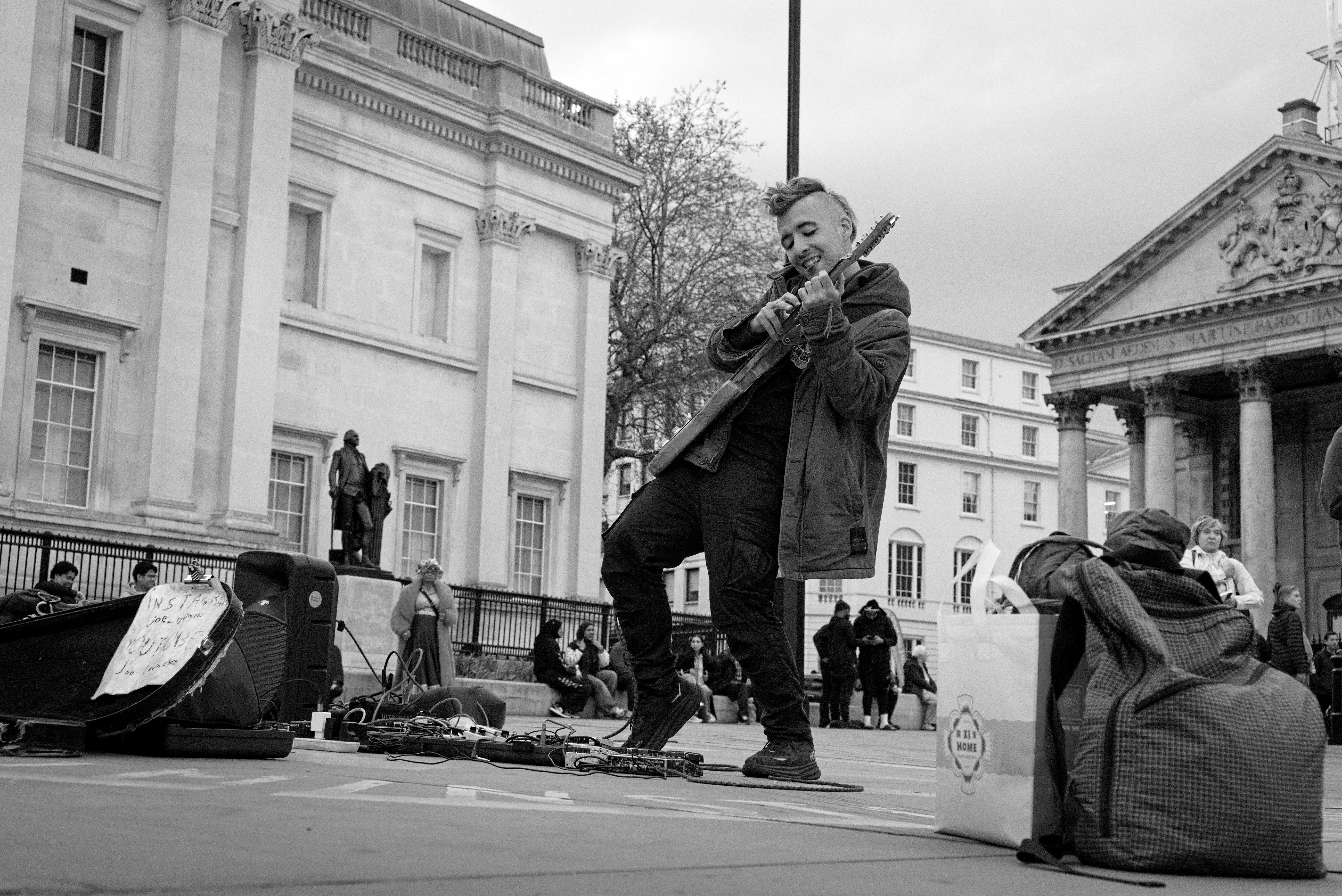 Street Virtuoso with Guitar in a Classical Plaza