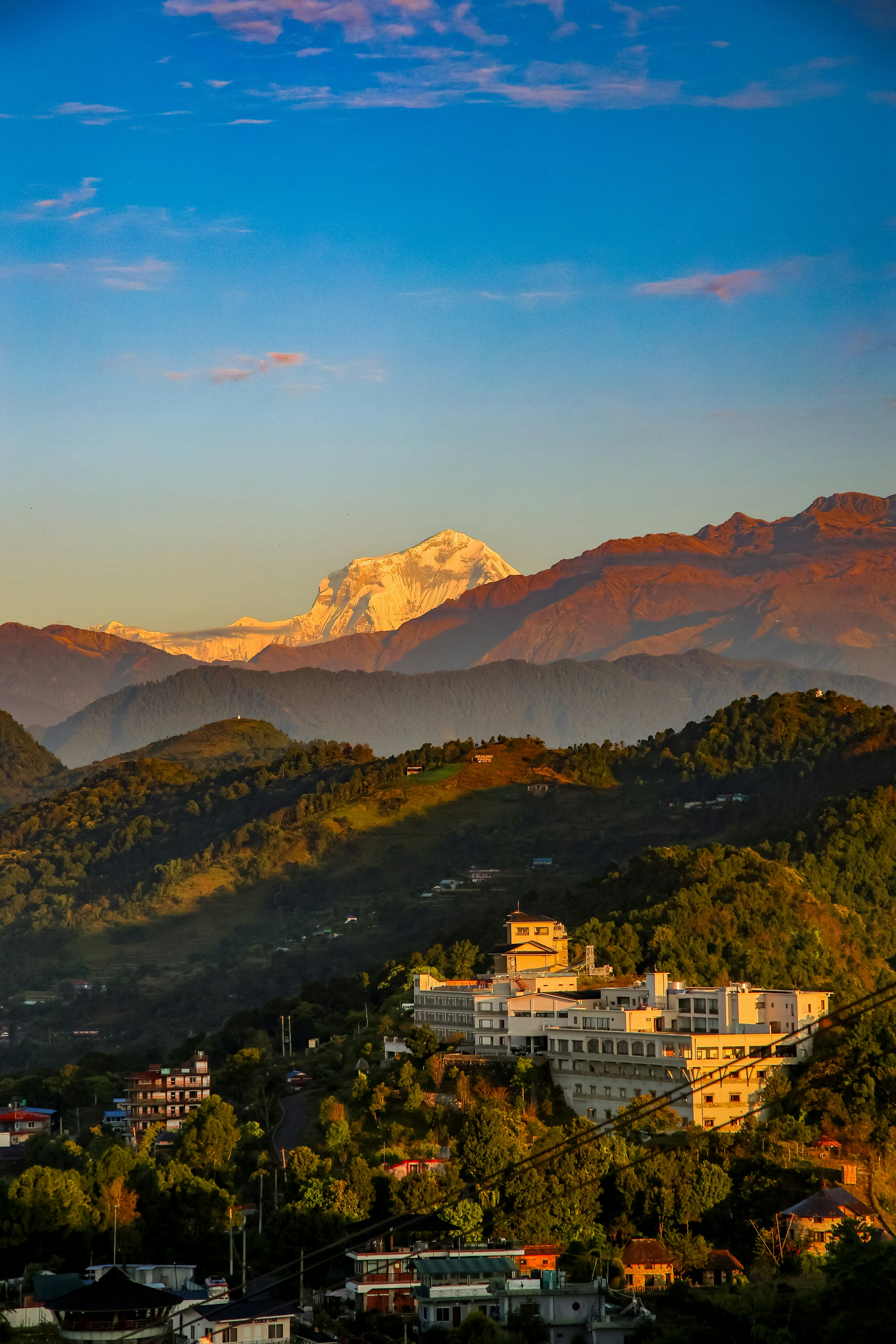 Golden Ridge: A Mountain Village Drenched in Sunset Light