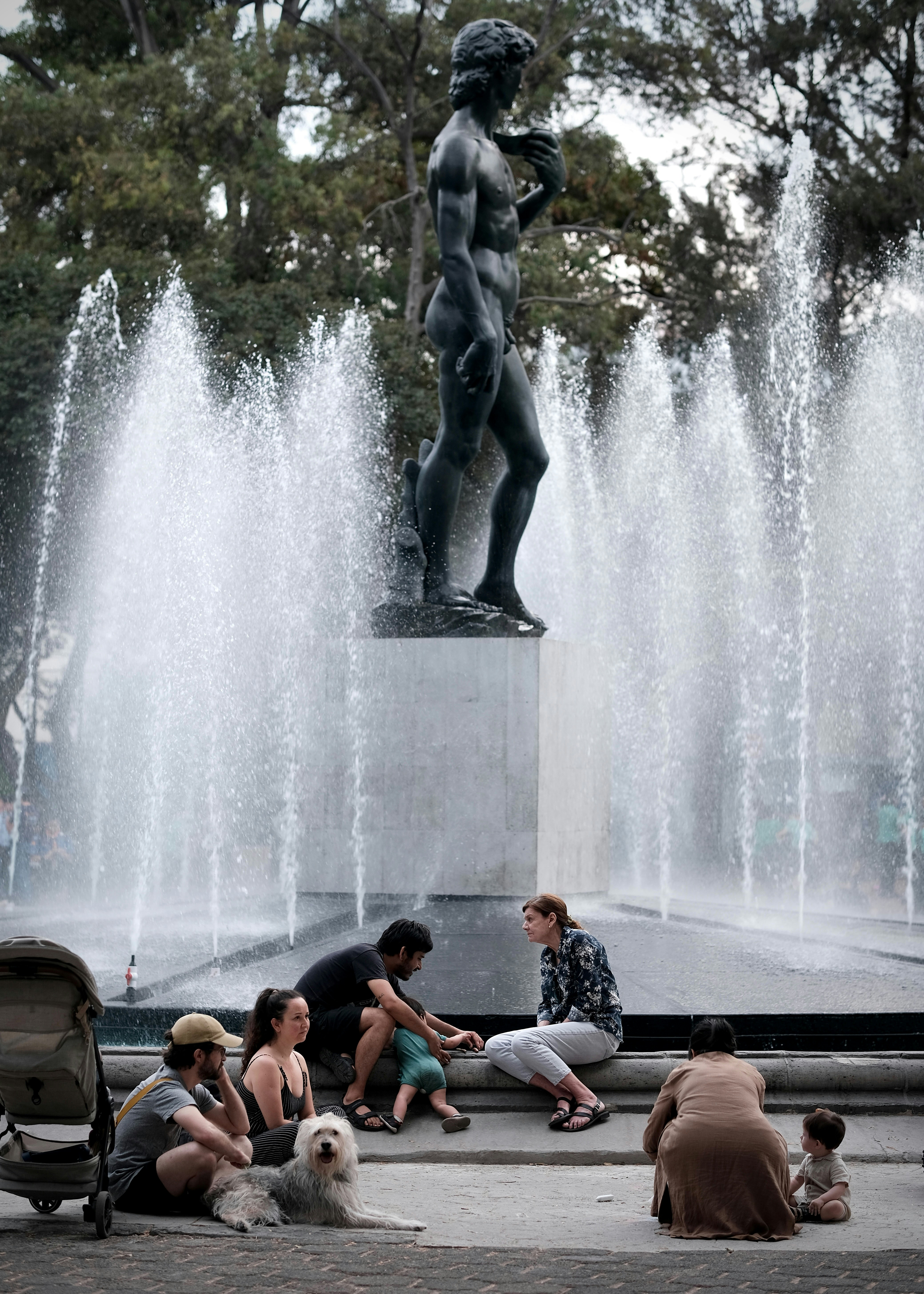Guardians of the Fountain: A Family Moment at the Statue