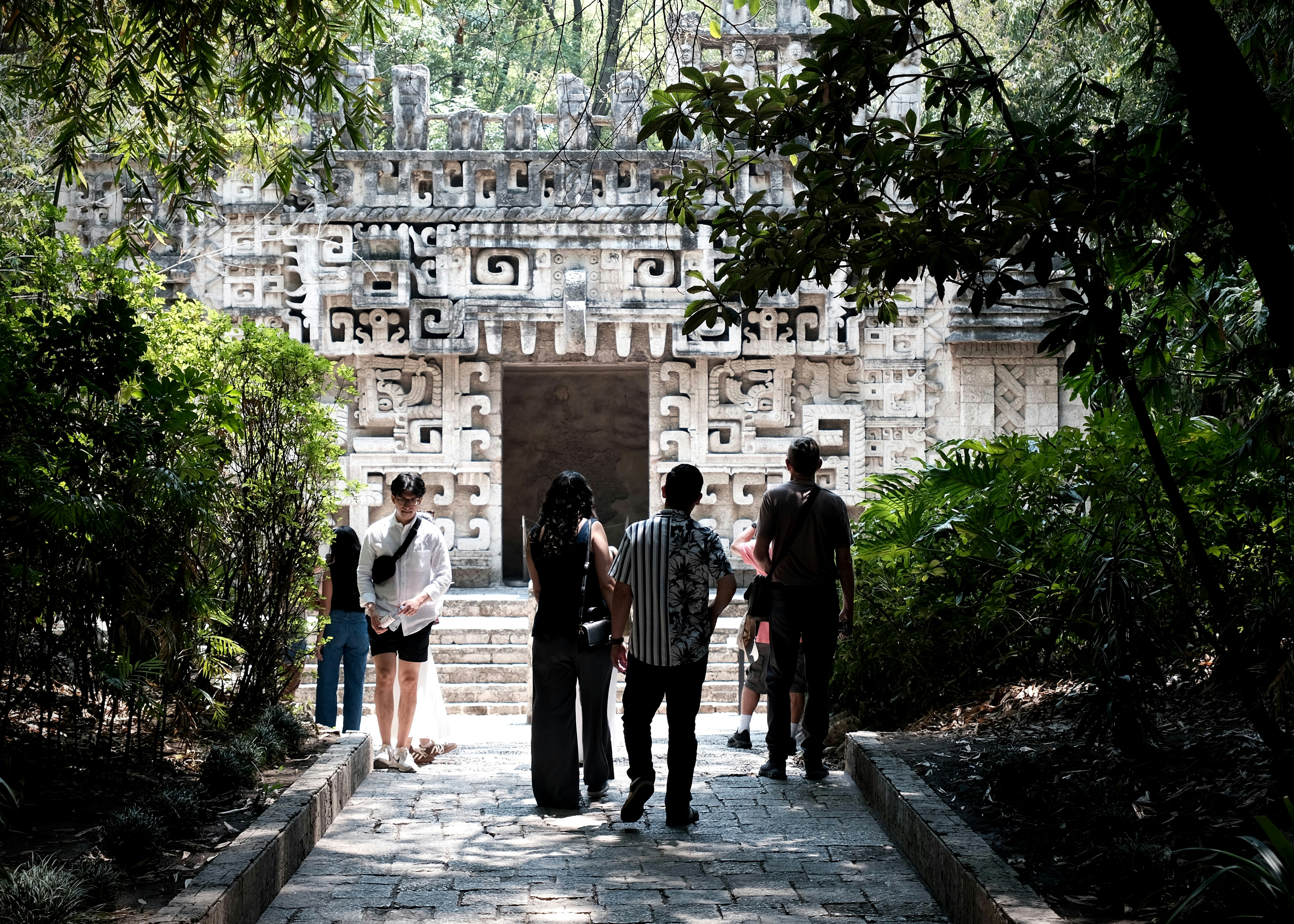 Stone Gateway and Travelers: A Quiet Ascent to the Carved Door