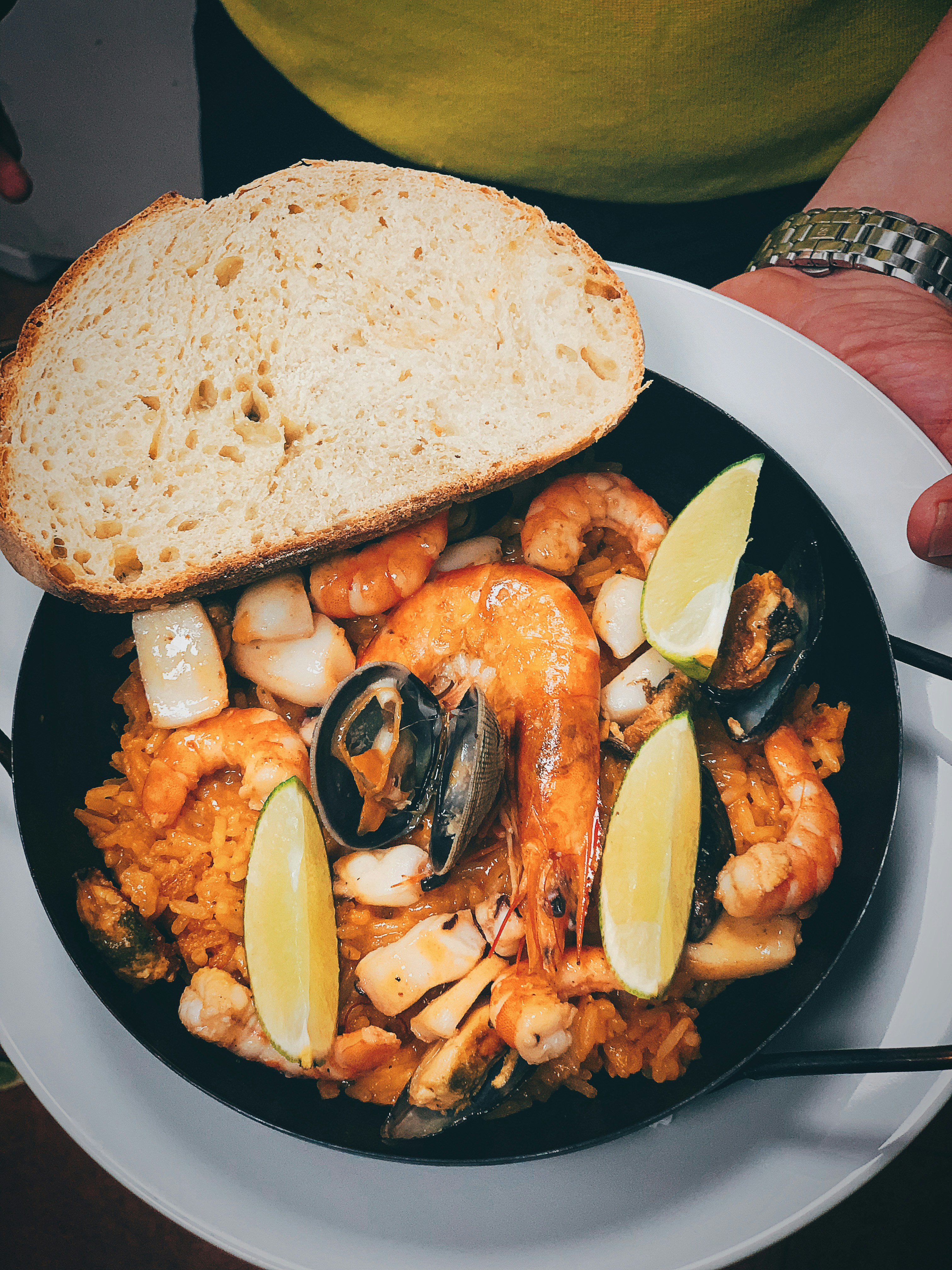 Seafood Skillet with Lemon Wedges and Toasted Bread