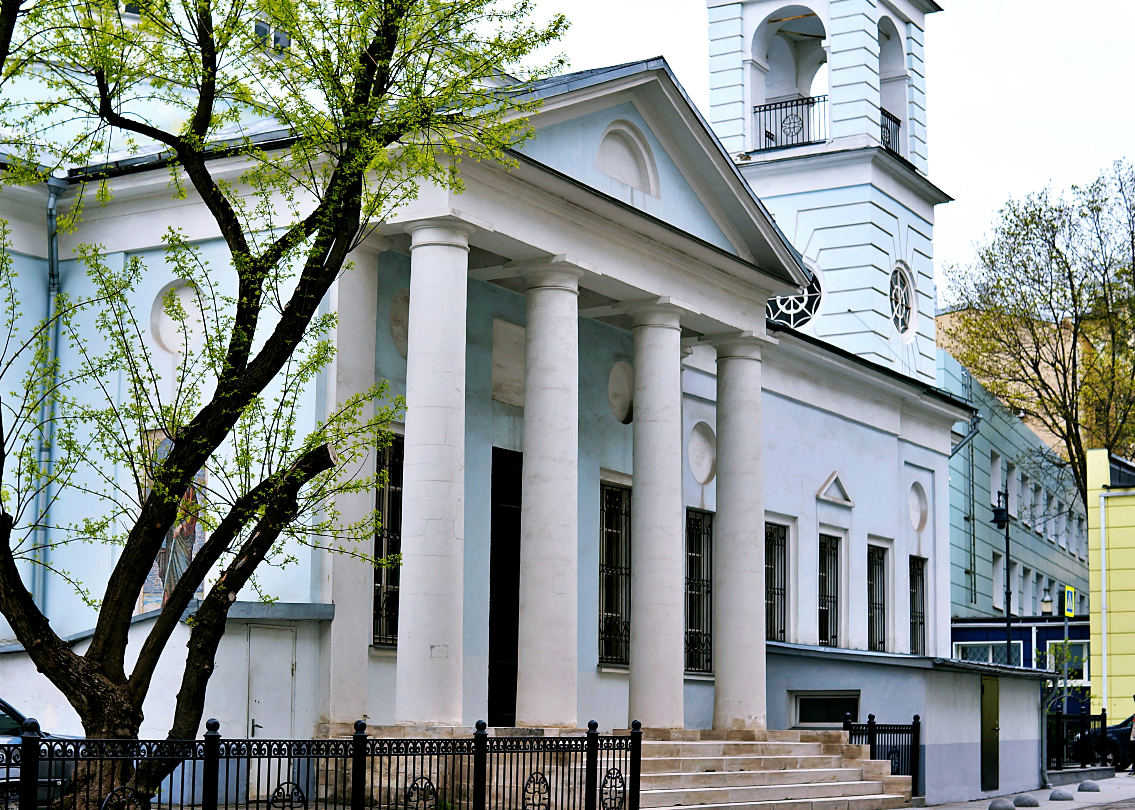 Classical Facade and Quiet Steps of a Blue Church