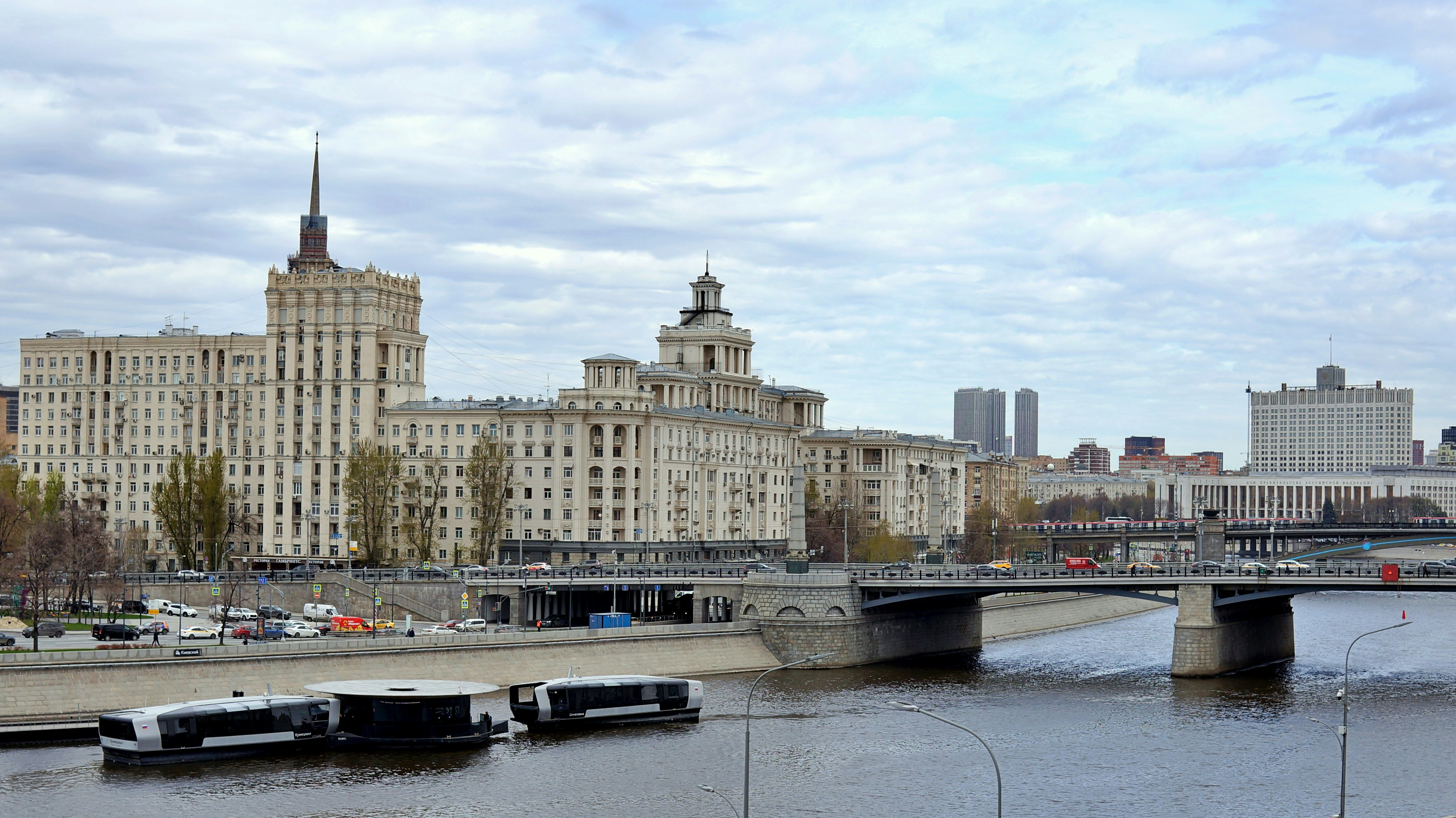 City in the Wake: A Riverside Ensemble Under a Soaring Sky
