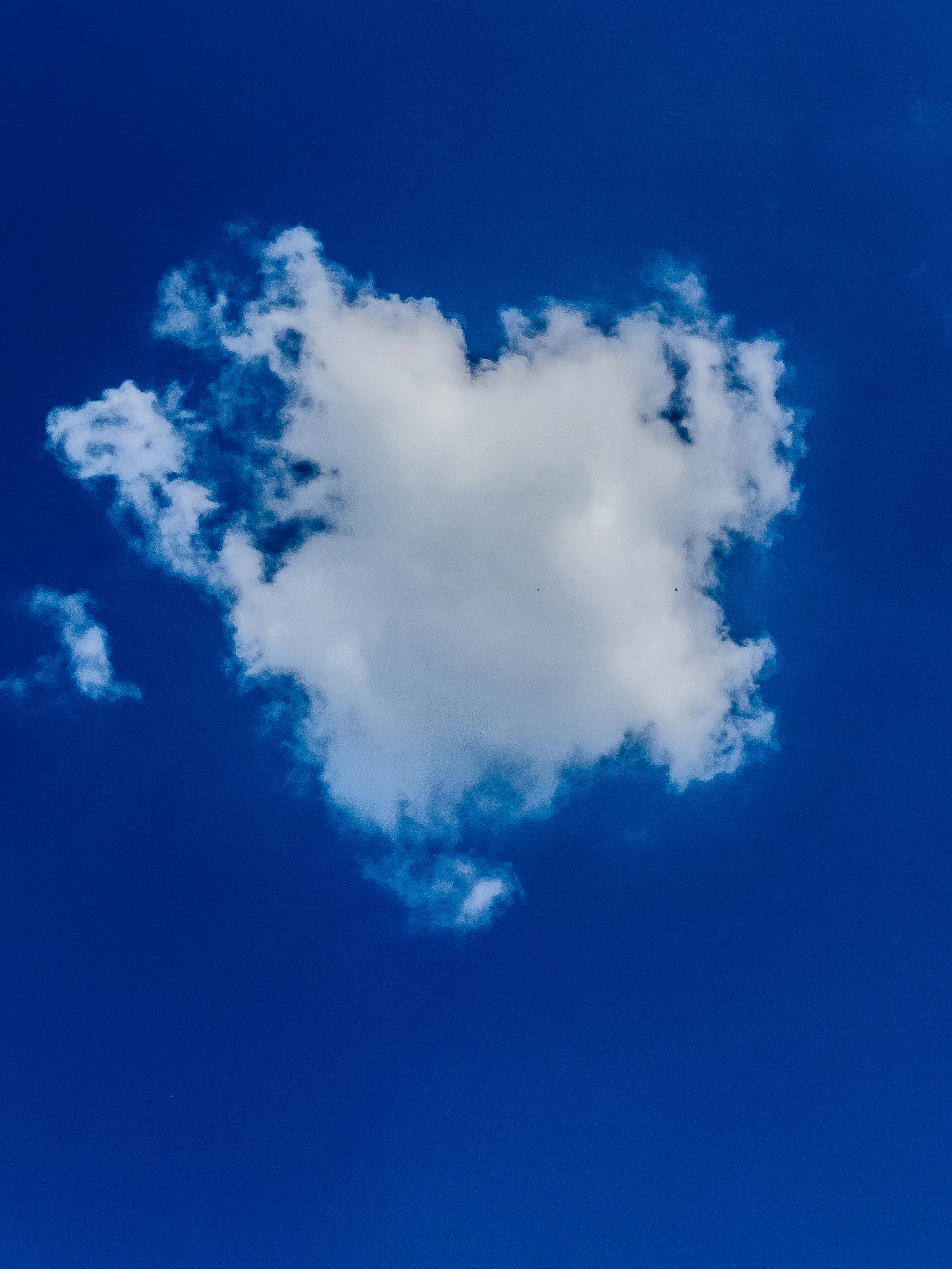 Solo Cloud Against a Pristine Blue Canvas