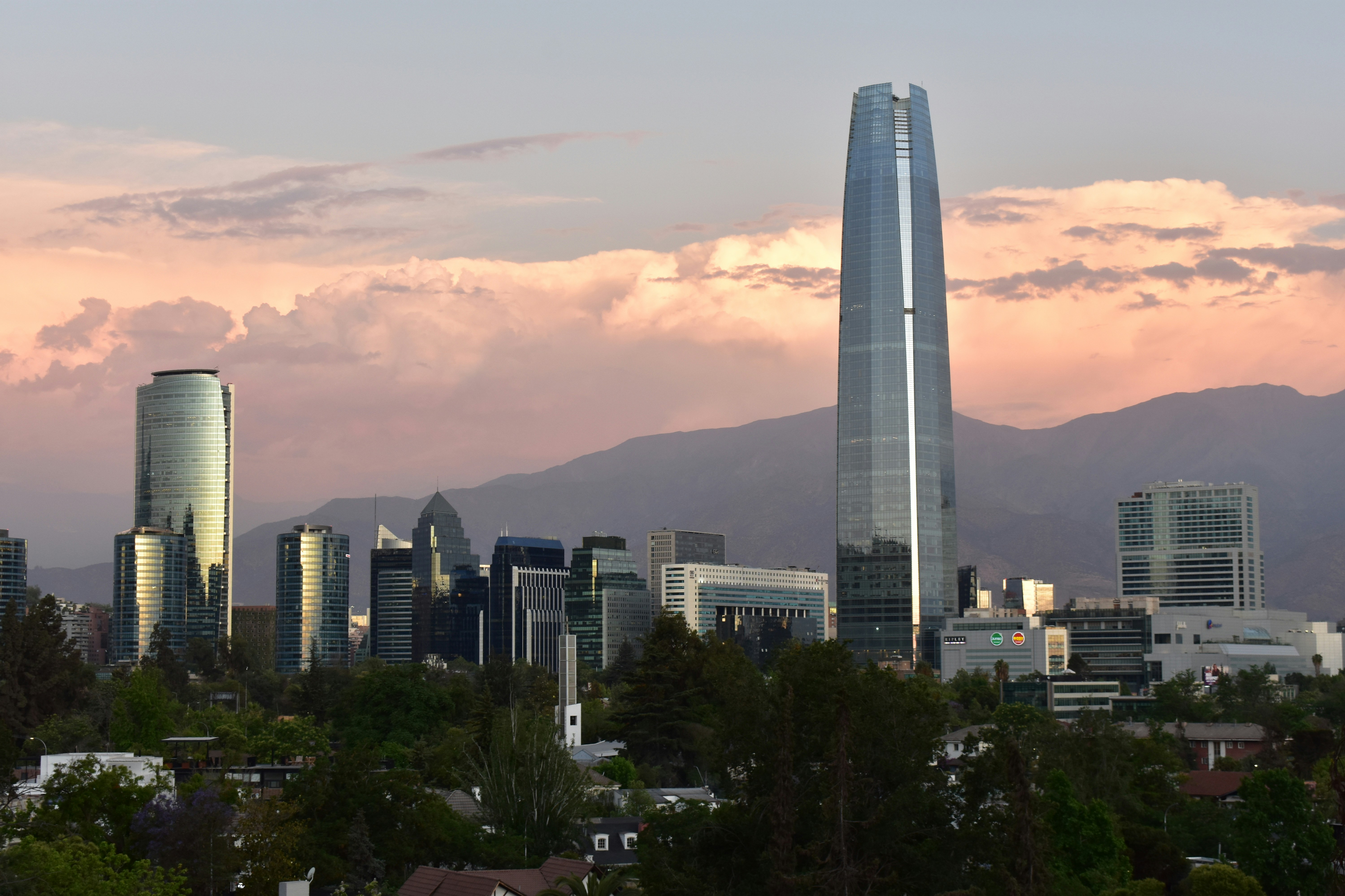 Vertical Giant: A City Skyline Crowned by a Glass Tower at Dusk