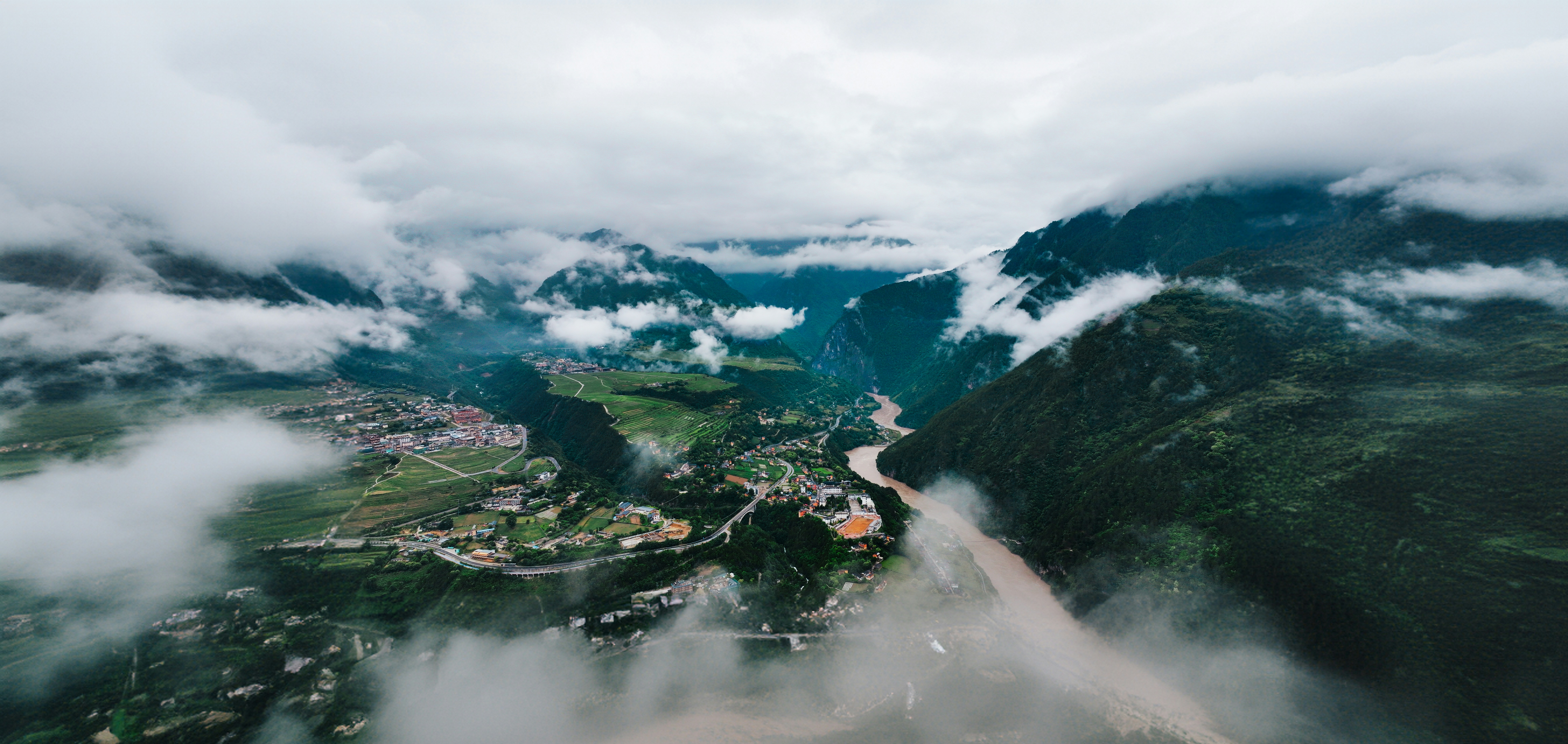 Valley Ribbon: Aerial Veins Through Misty Gorge