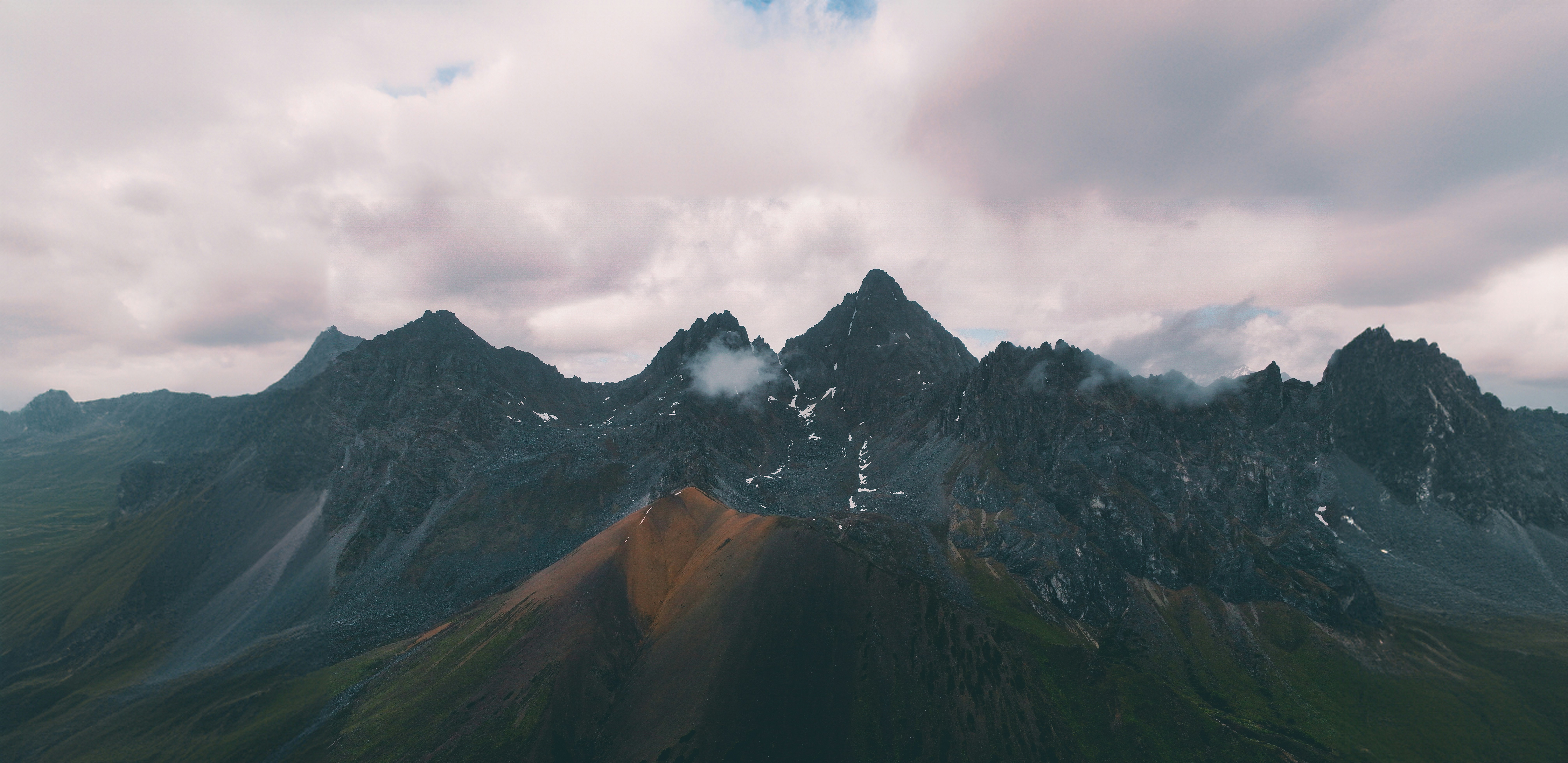 Ridgeline Crown: The Looming Peaks at Dusk