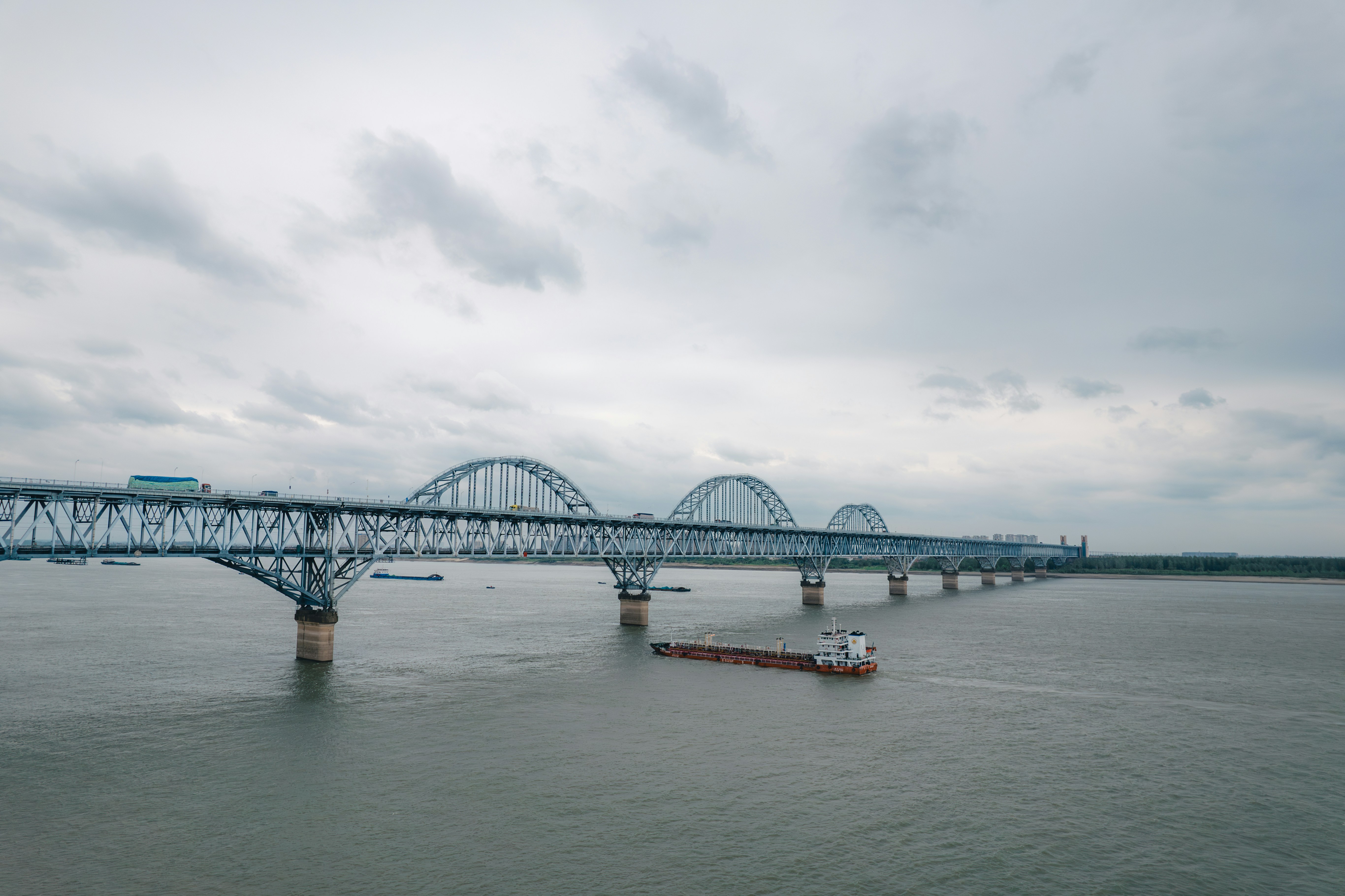 Across the Currents: A River Bridge Tracks the Horizon