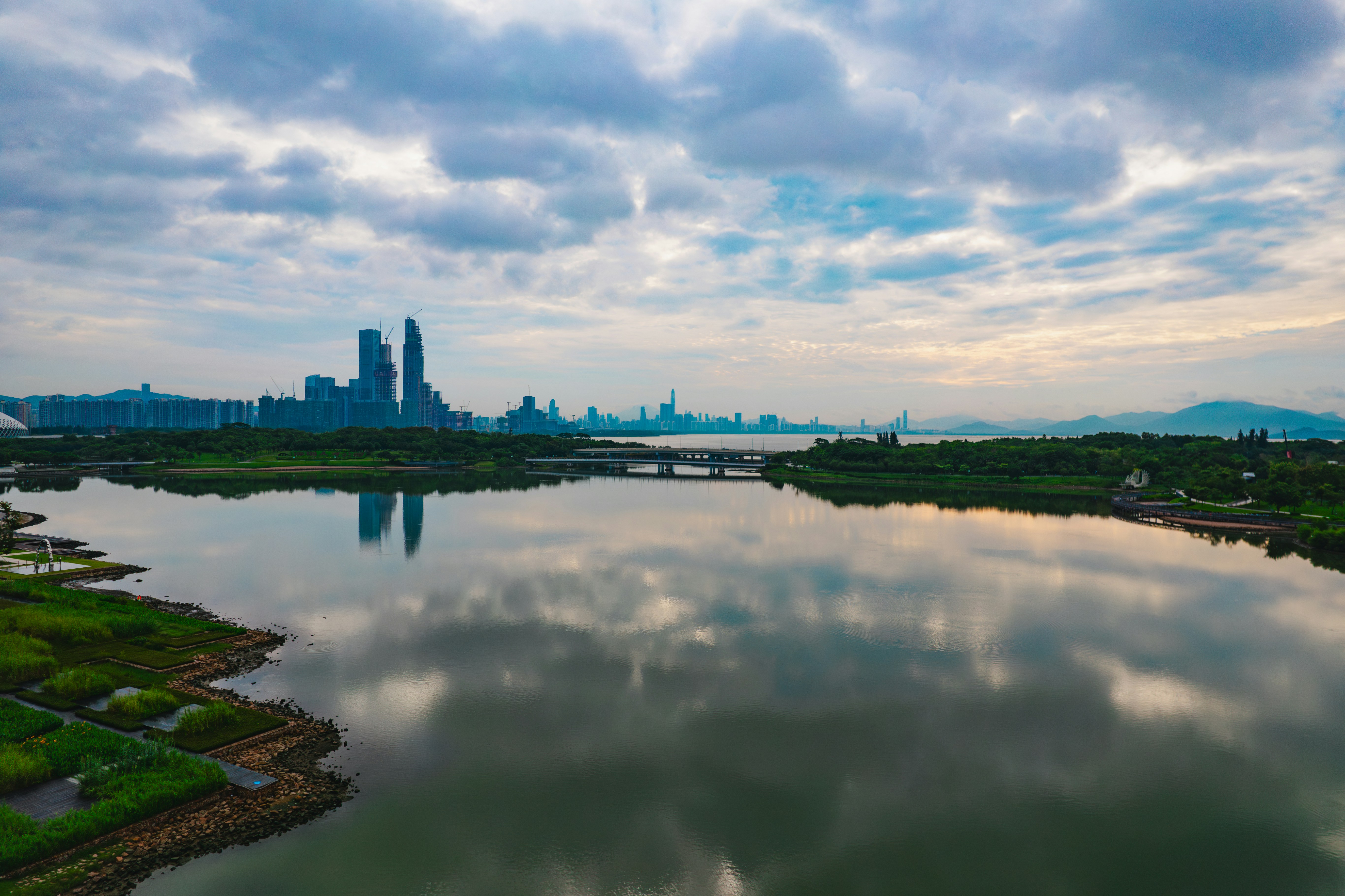 Midday Skyline Reflections Over a Serene River