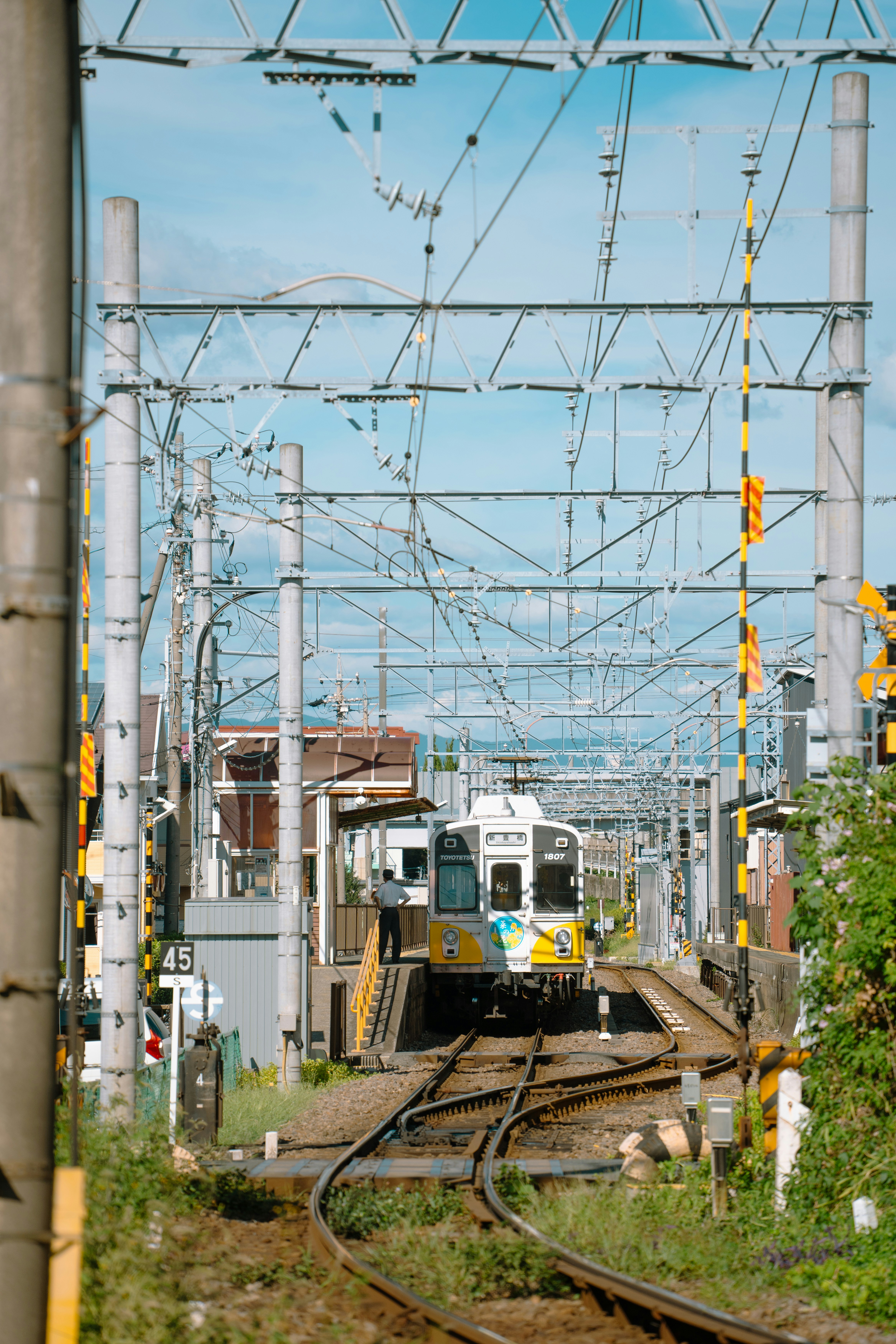 Urban Rails: The Lone Train Converging Through a Tiled Skyline of Wires
