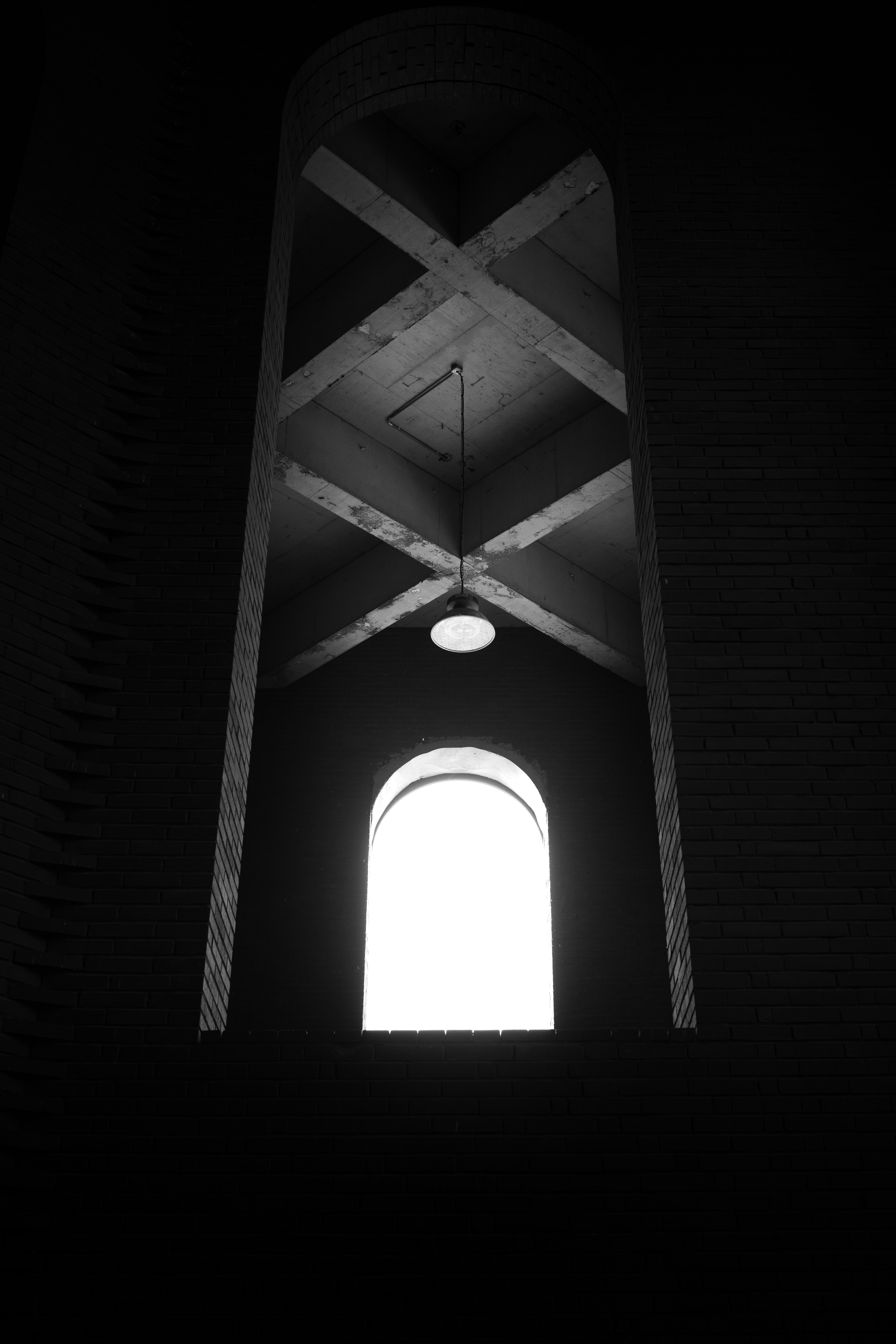 Cruciform beams and radiant window: a chapel’s vertical geometry in shadow