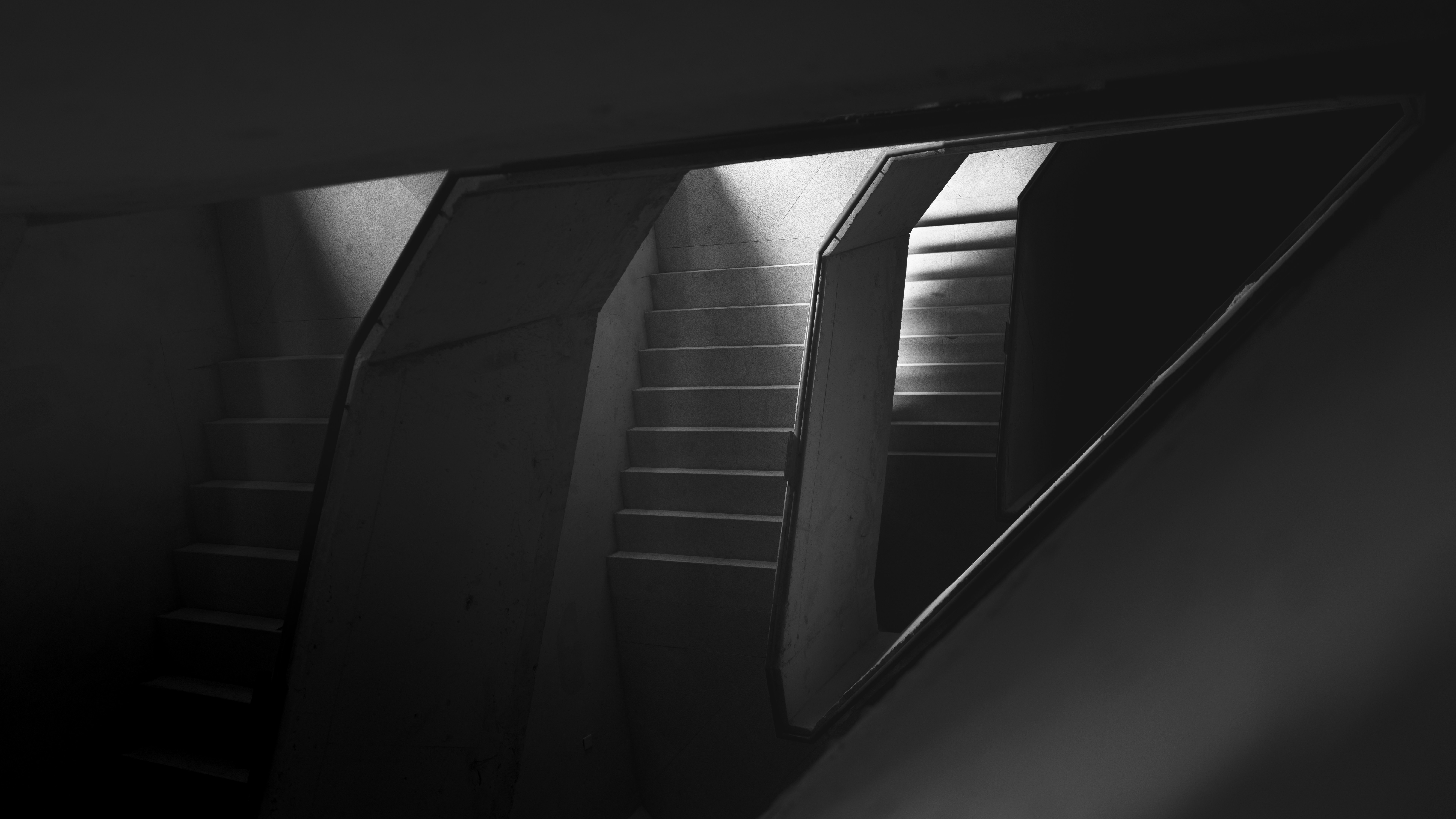 Stairwell Echoes: Geometric Light in Shadowed Concrete