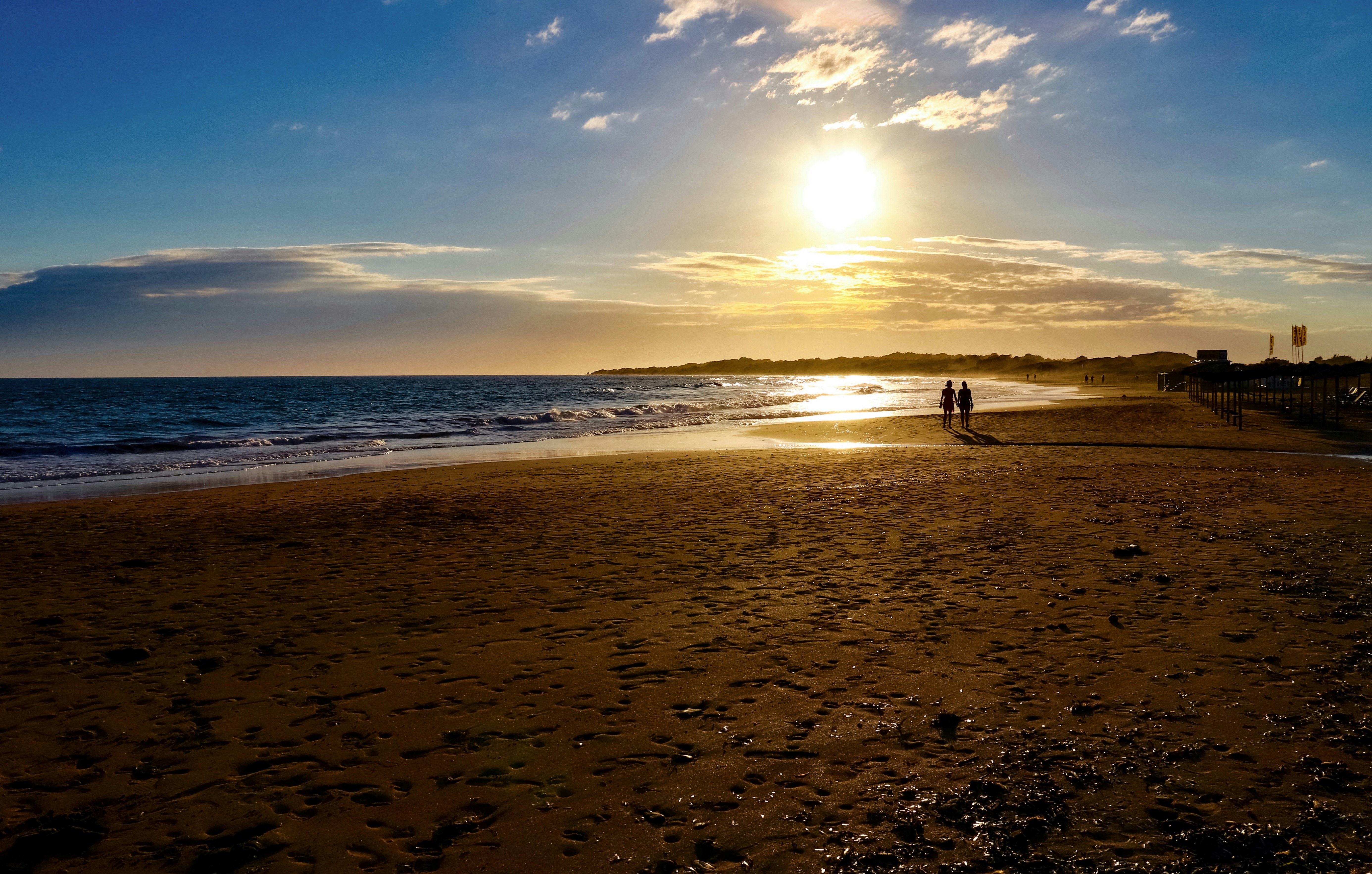 Sunlit Tides: A Quiet Beach at Dusk