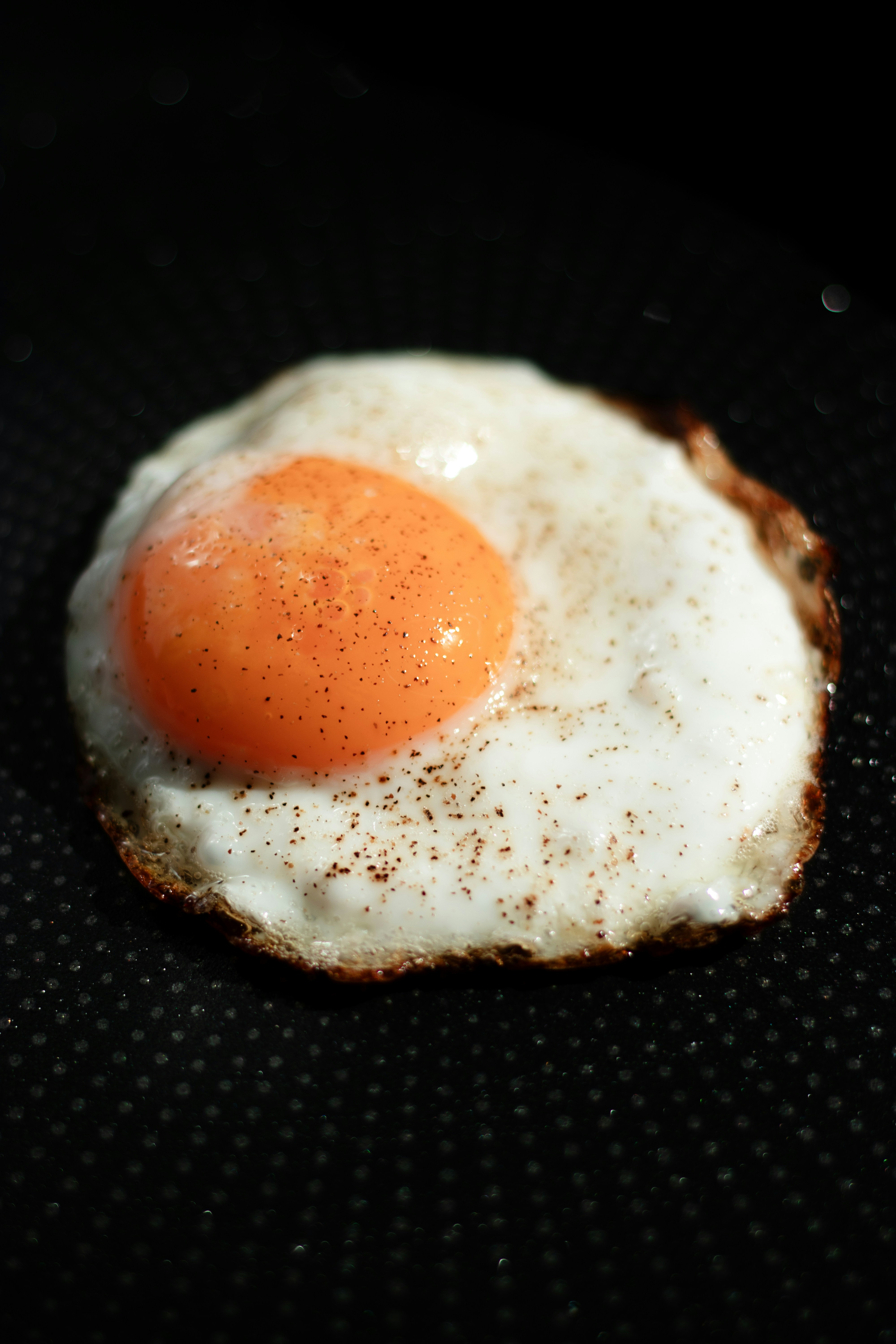 Sunny-side Focus: A Fried Egg Portrait in a Nonstick Scene