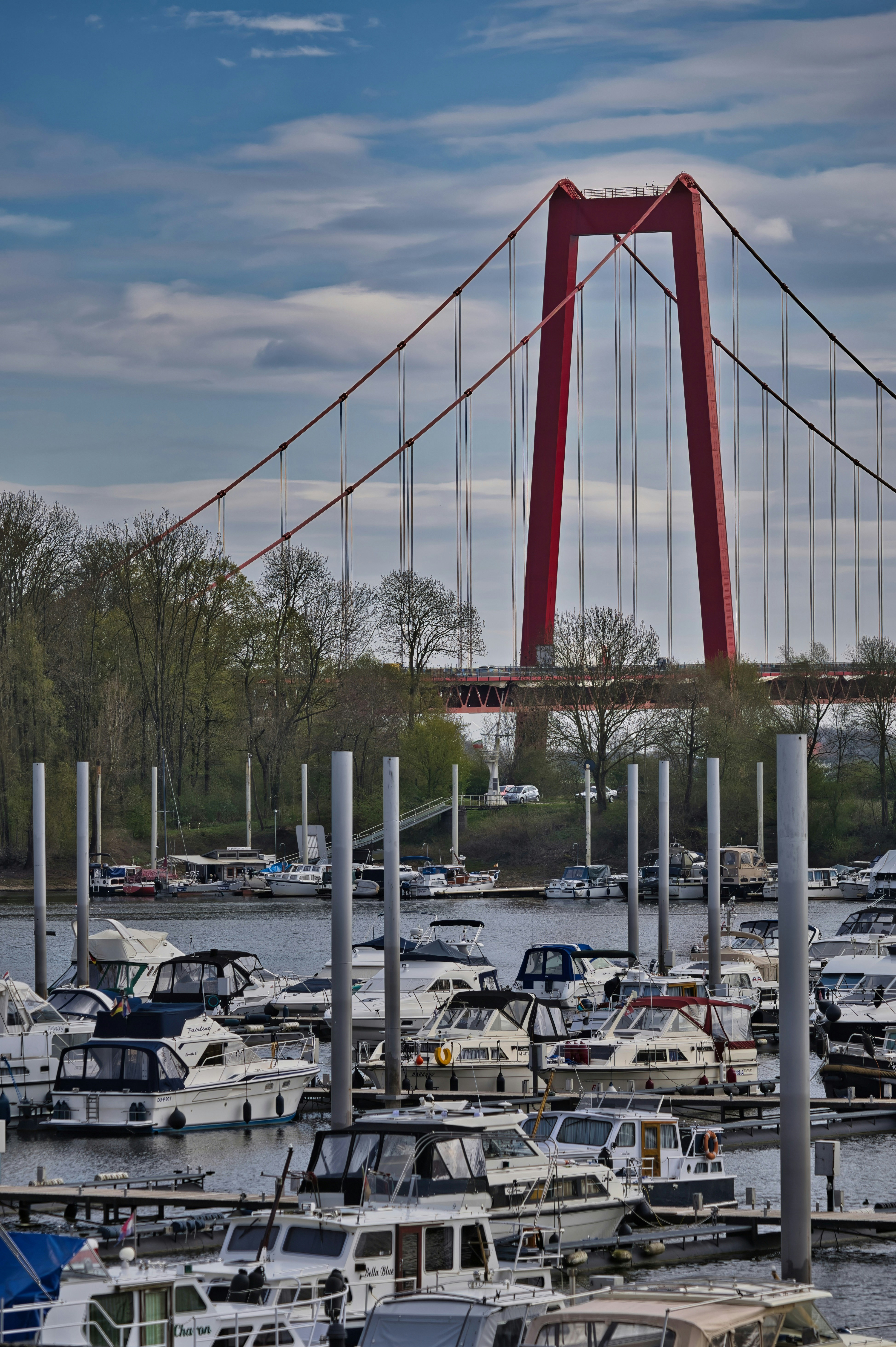 Red Arch in the Marina: A Bridge Framing Boats and Sky
