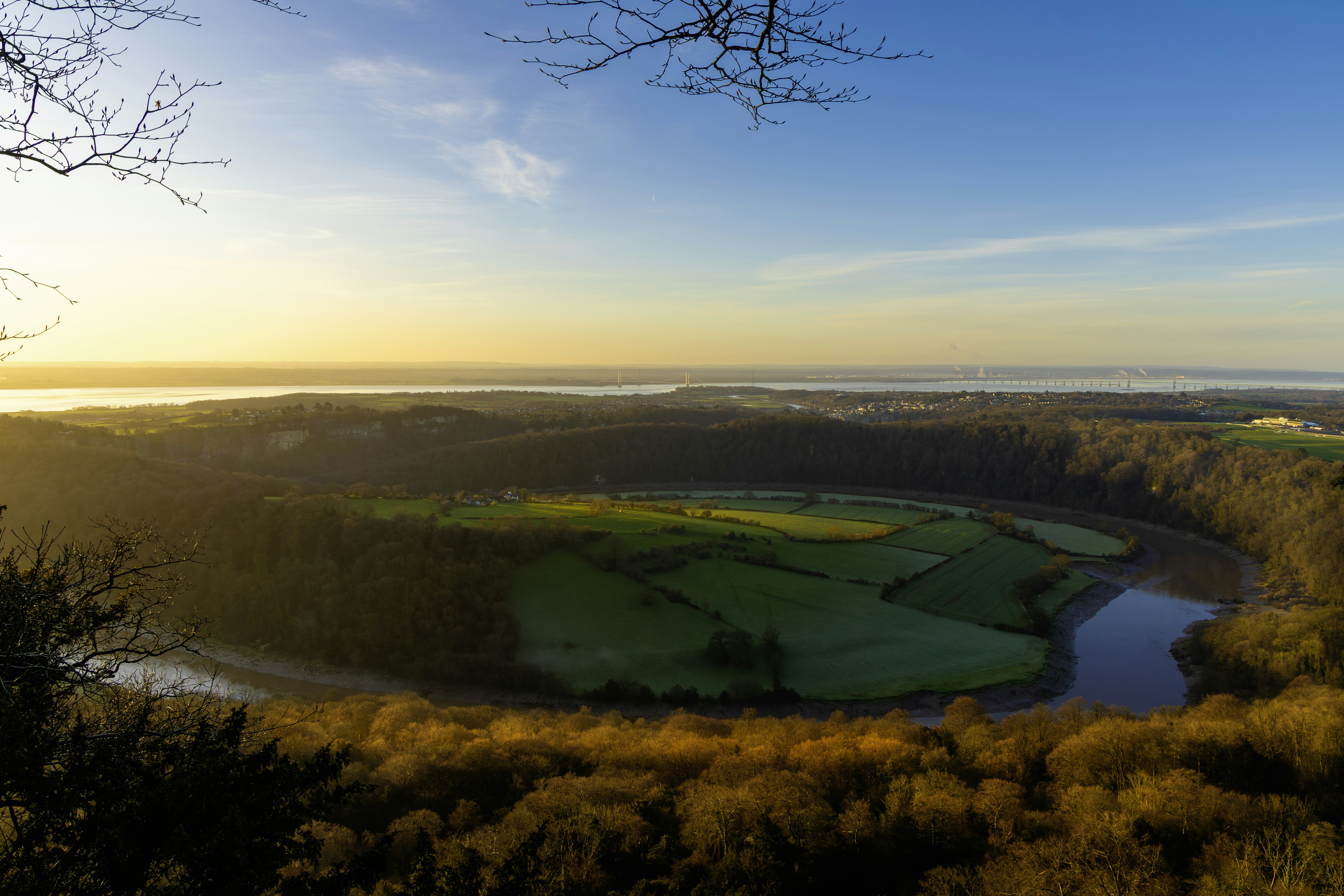 Sunlit River Bend Over a Golden Vale