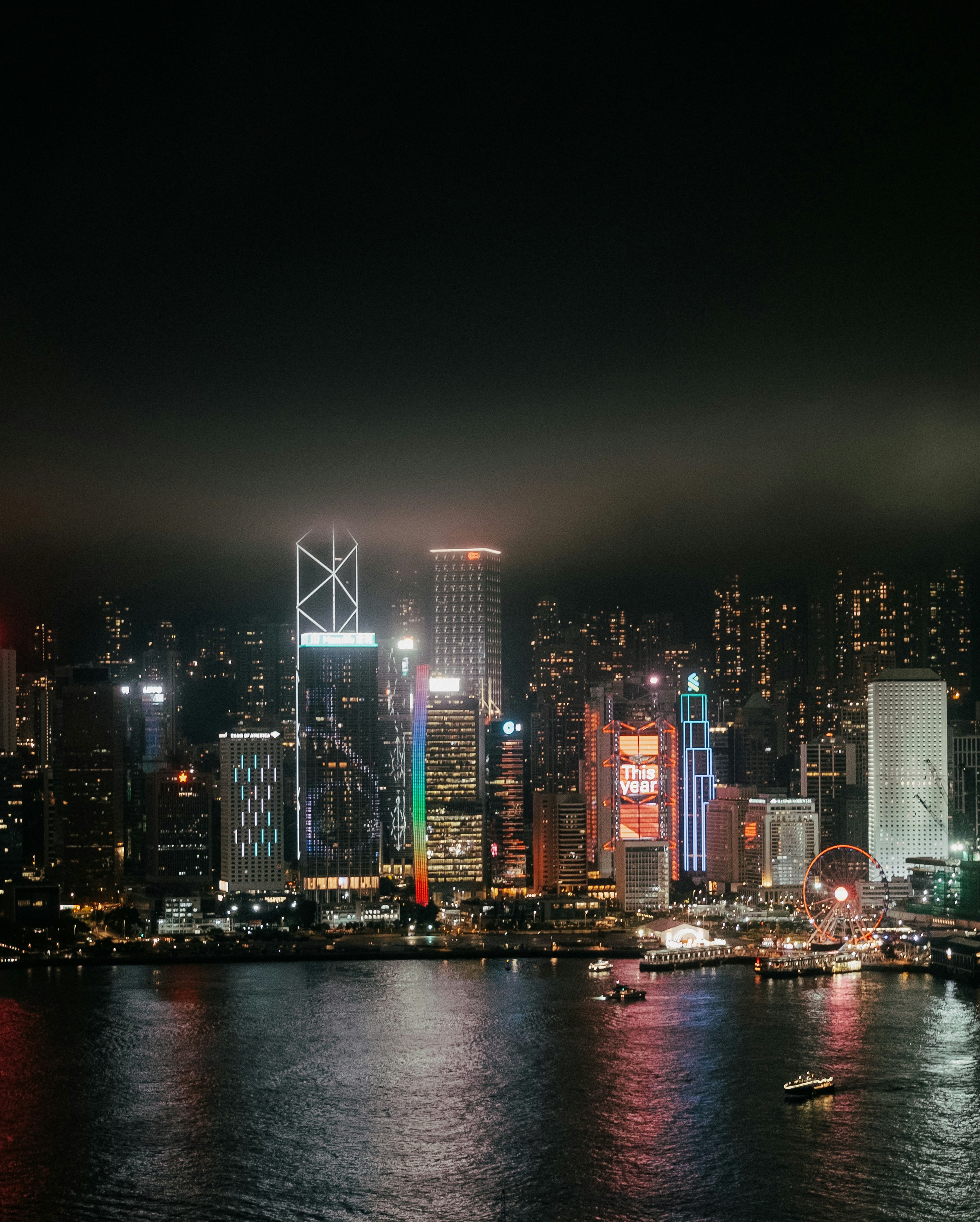 Neon Harbor: City Lights Reflect on Quiet Waves