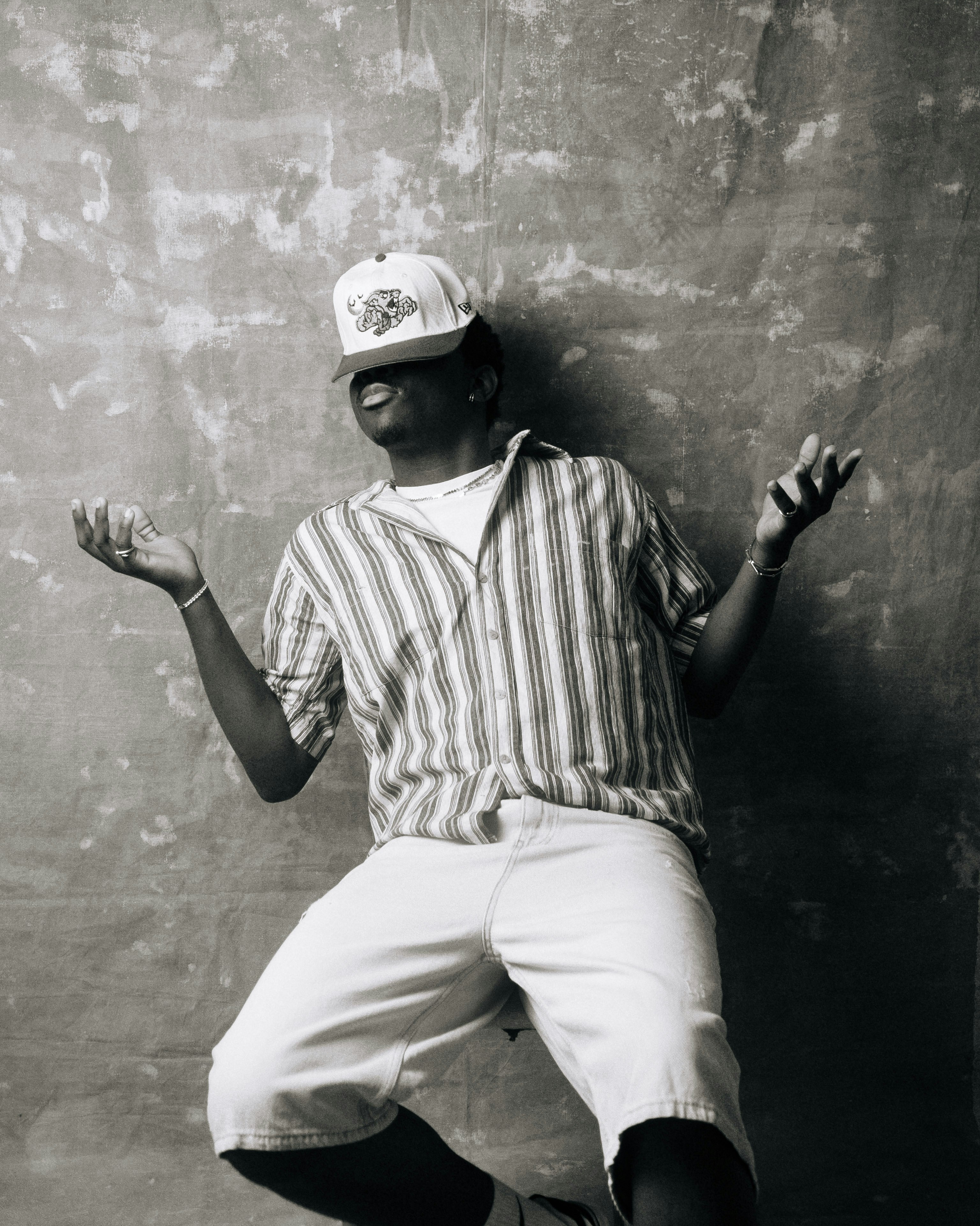 Shadowed Groove: A Relaxed Moment in a Striped Shirt