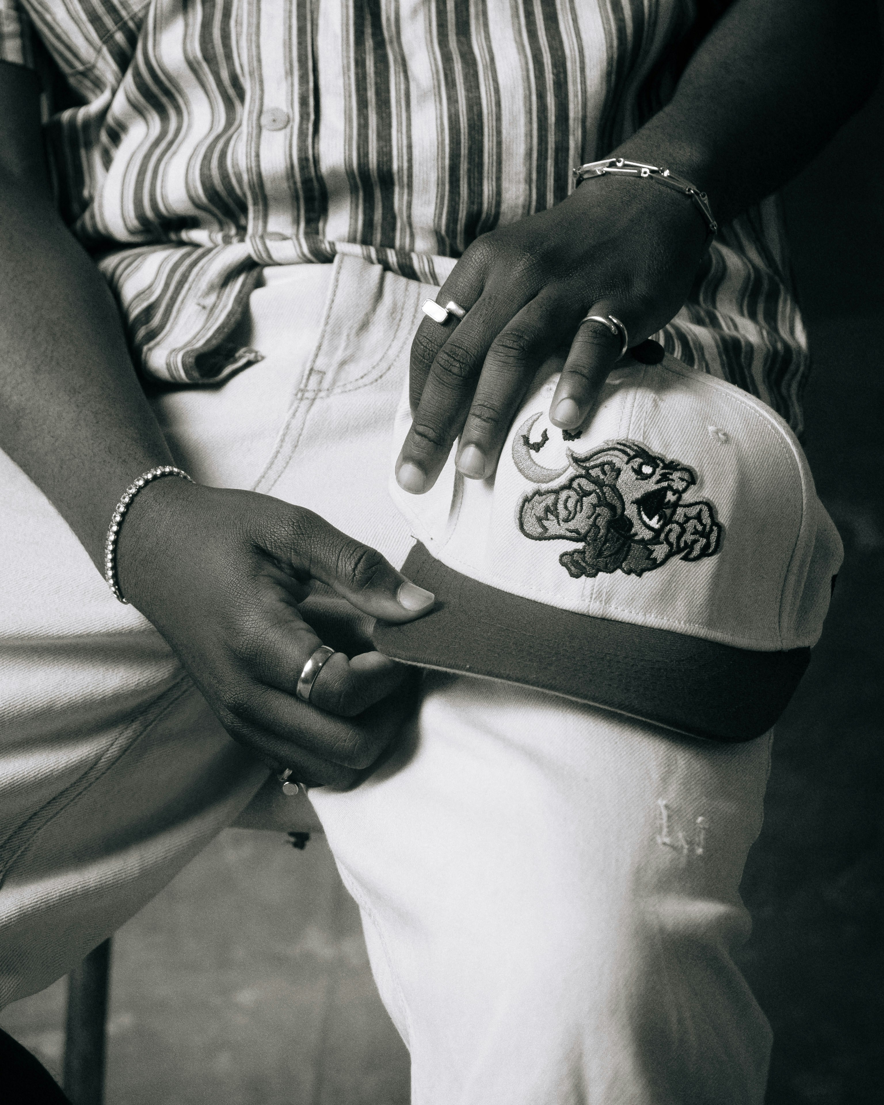Hands on a Cap: Personal Style and Tattoo Detail