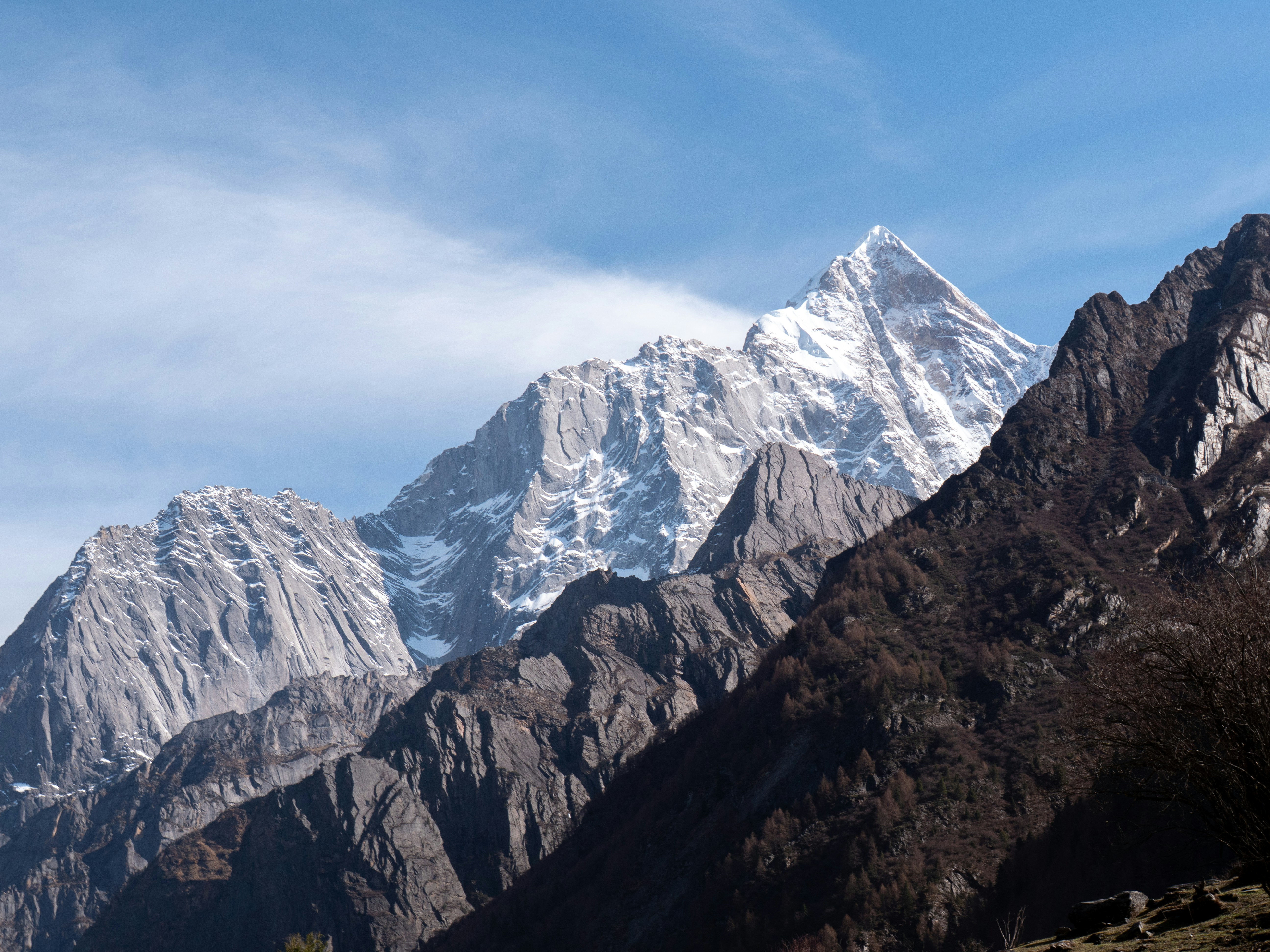 Snow-capped Peak Piercing a Clear Alpine Sky