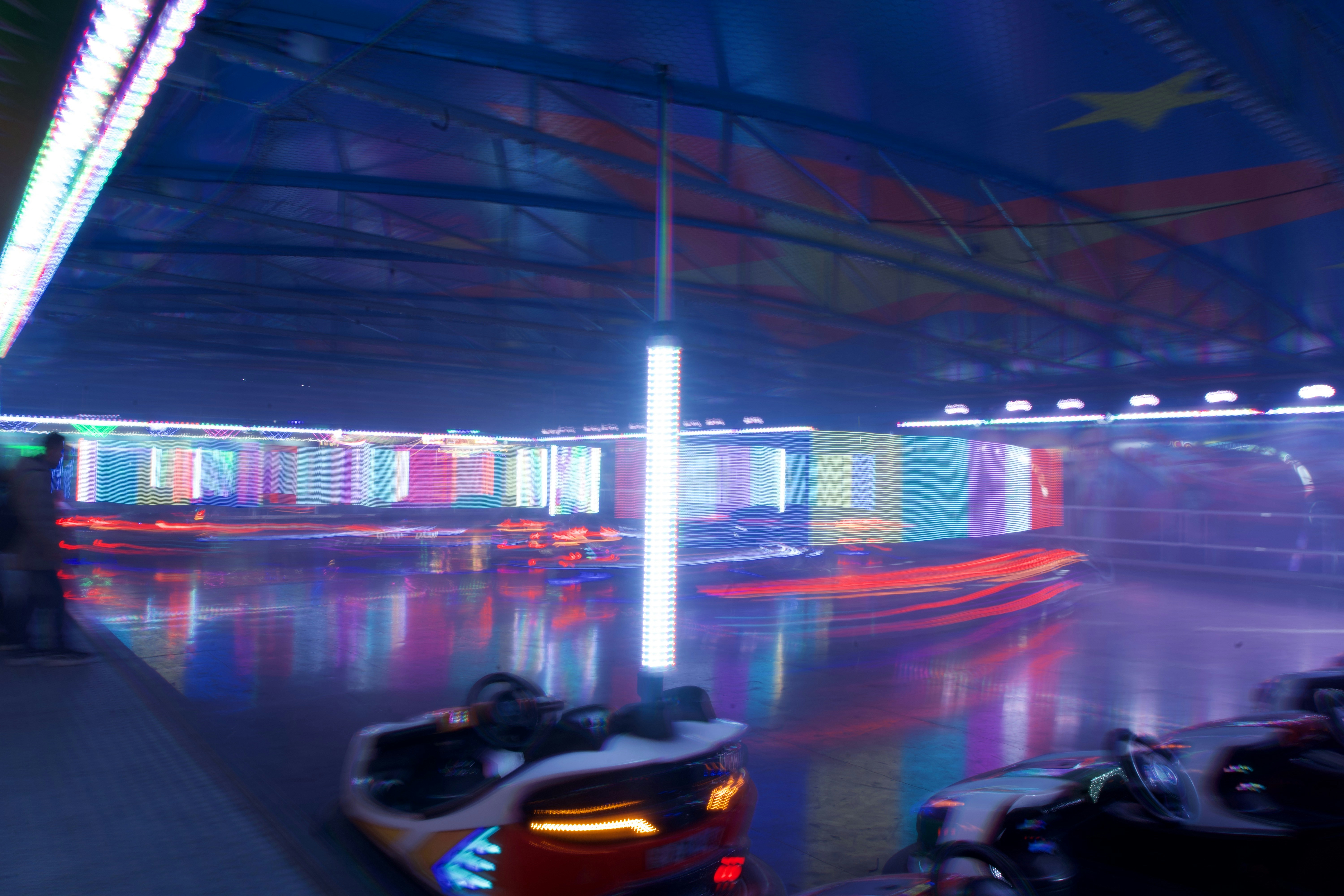 Neon Carousel: Blurred Lights Over a Water-Pilled Ride