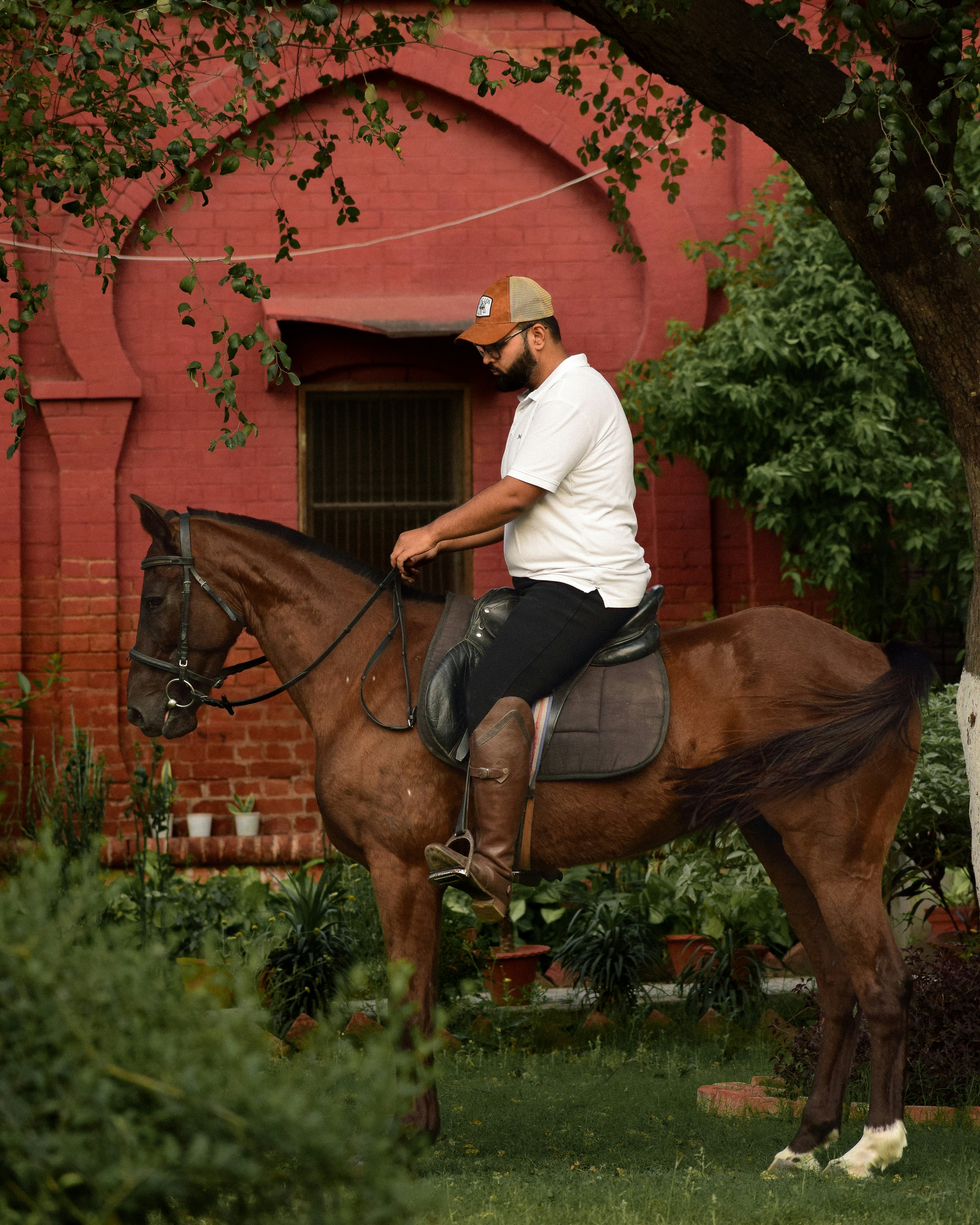 Rider in White Stride: Calm Focus on a Red Brick Backdrop