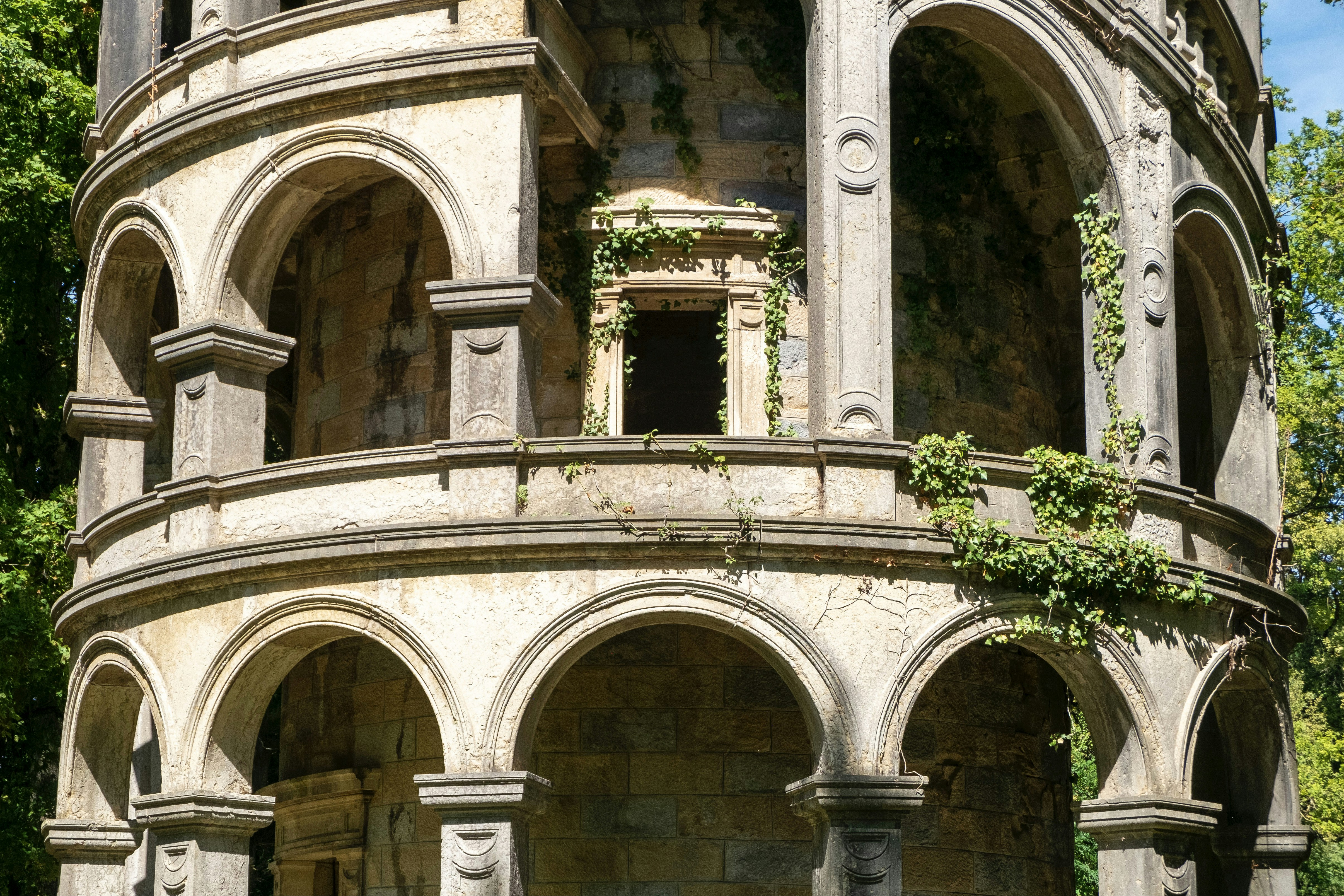 Overgrown Colonnade: A Timeworn Ruin Beneath Verdant Vines
