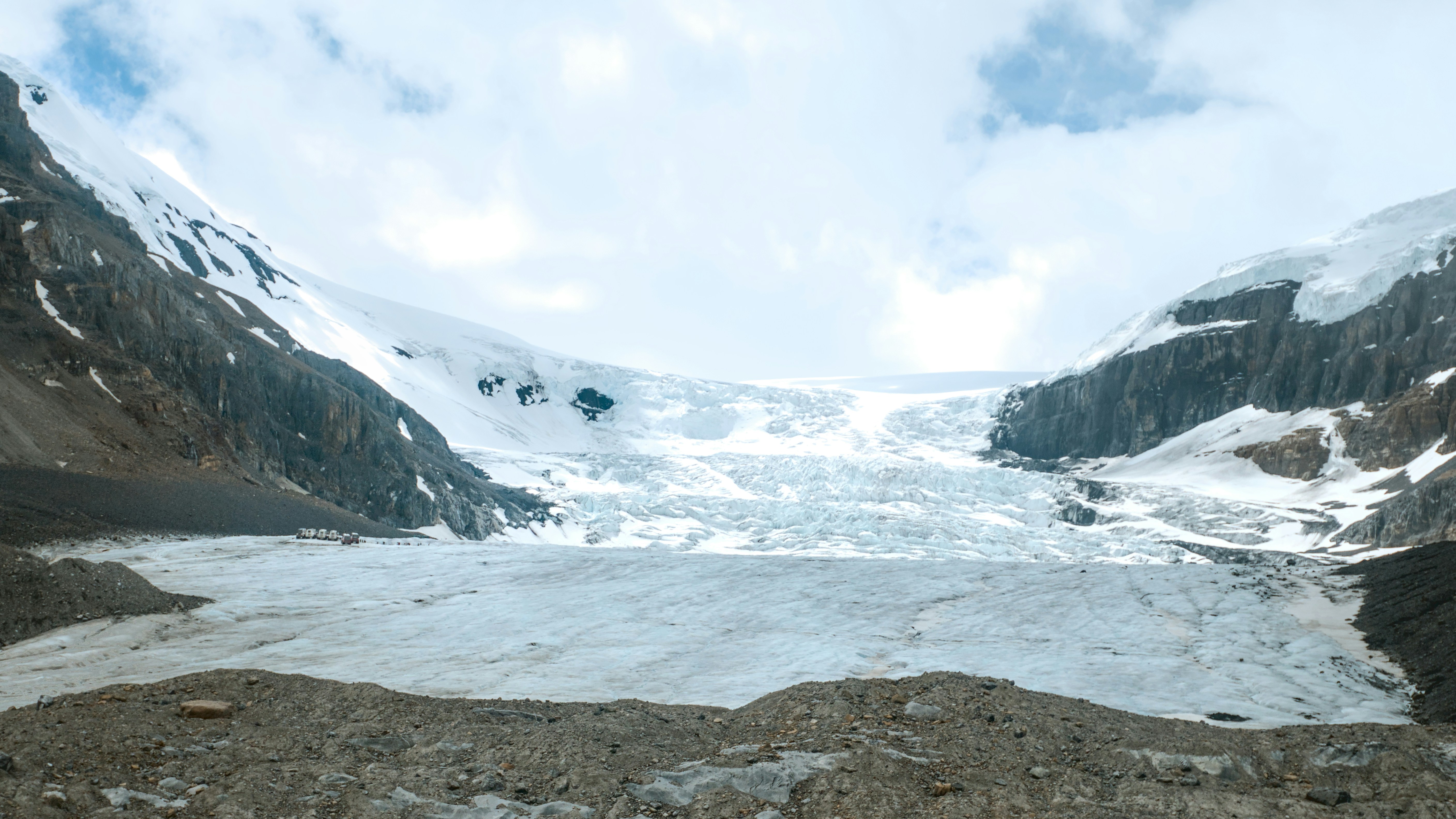 Glacier Gate: A frozen river carving a valley between looming, barn-white cliffs