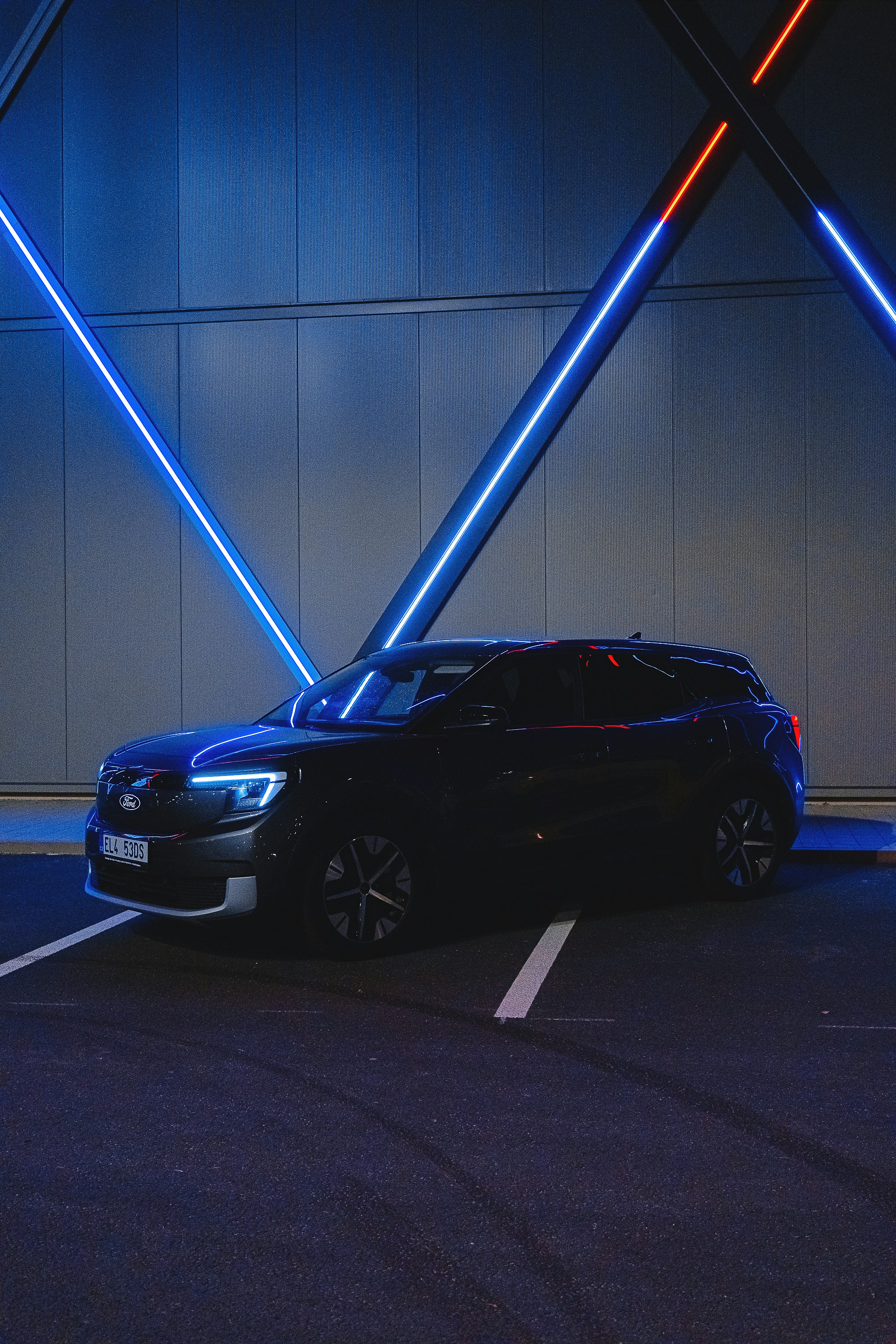 Neon Lines and Shadow: A Night Drive Under Industrial Crimsons