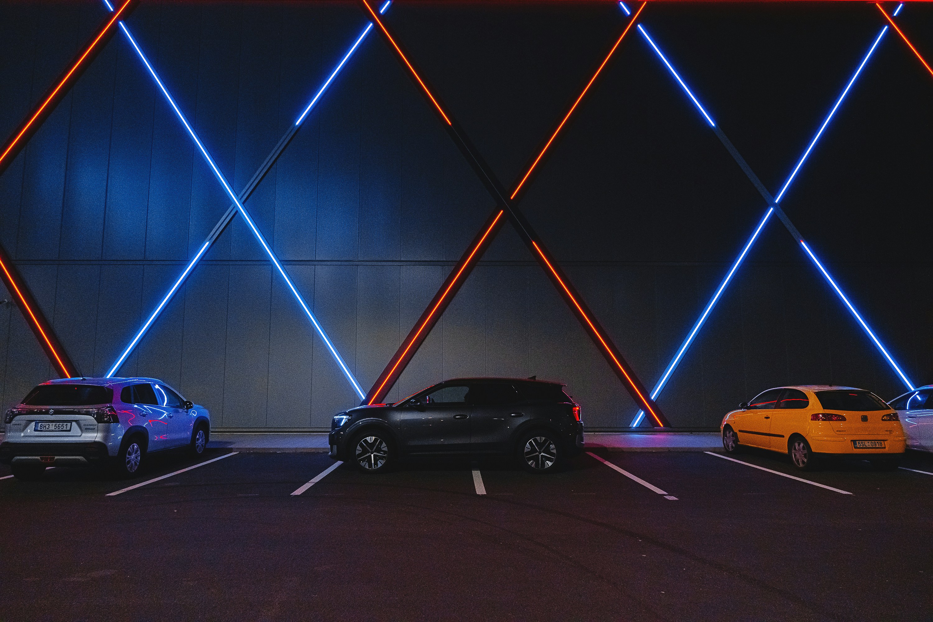 Neon Cathedral of Parking: Cars Beneath Luminous Diagonal Beams