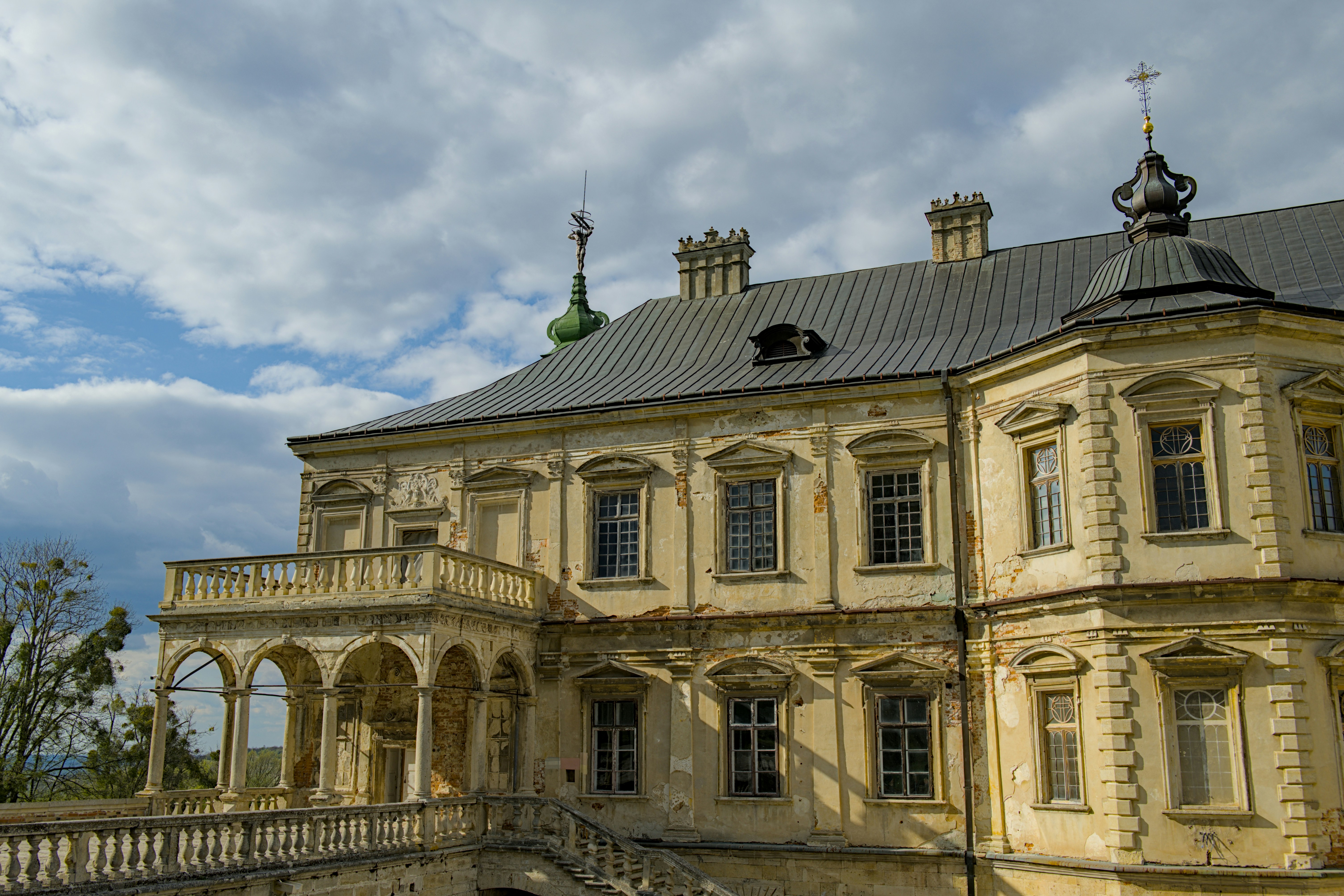 Sunlit Facade of a Classical Estate with Arcaded Terrace