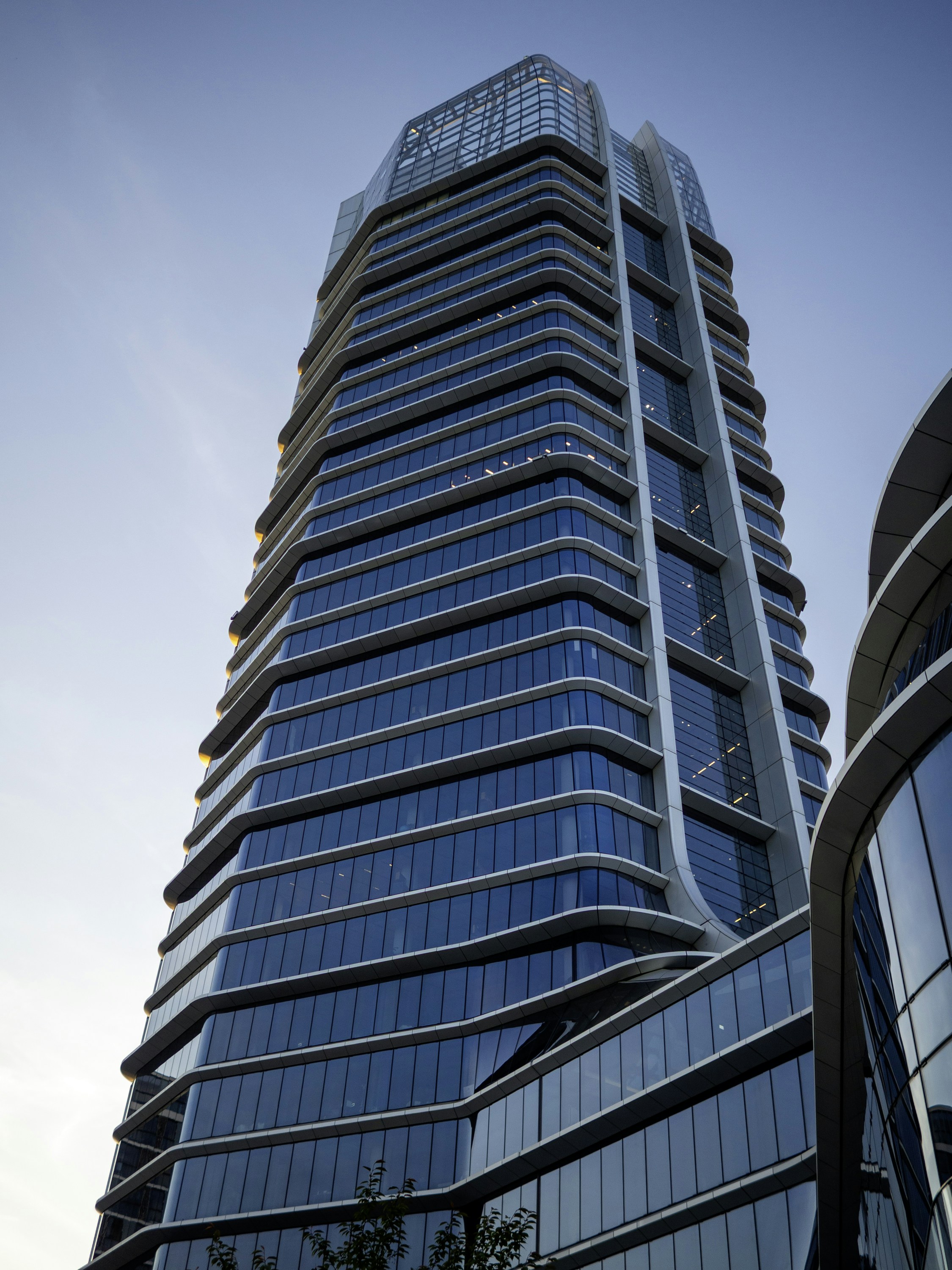 Skyward Facets: A Modern Tower Reaching into the Blue