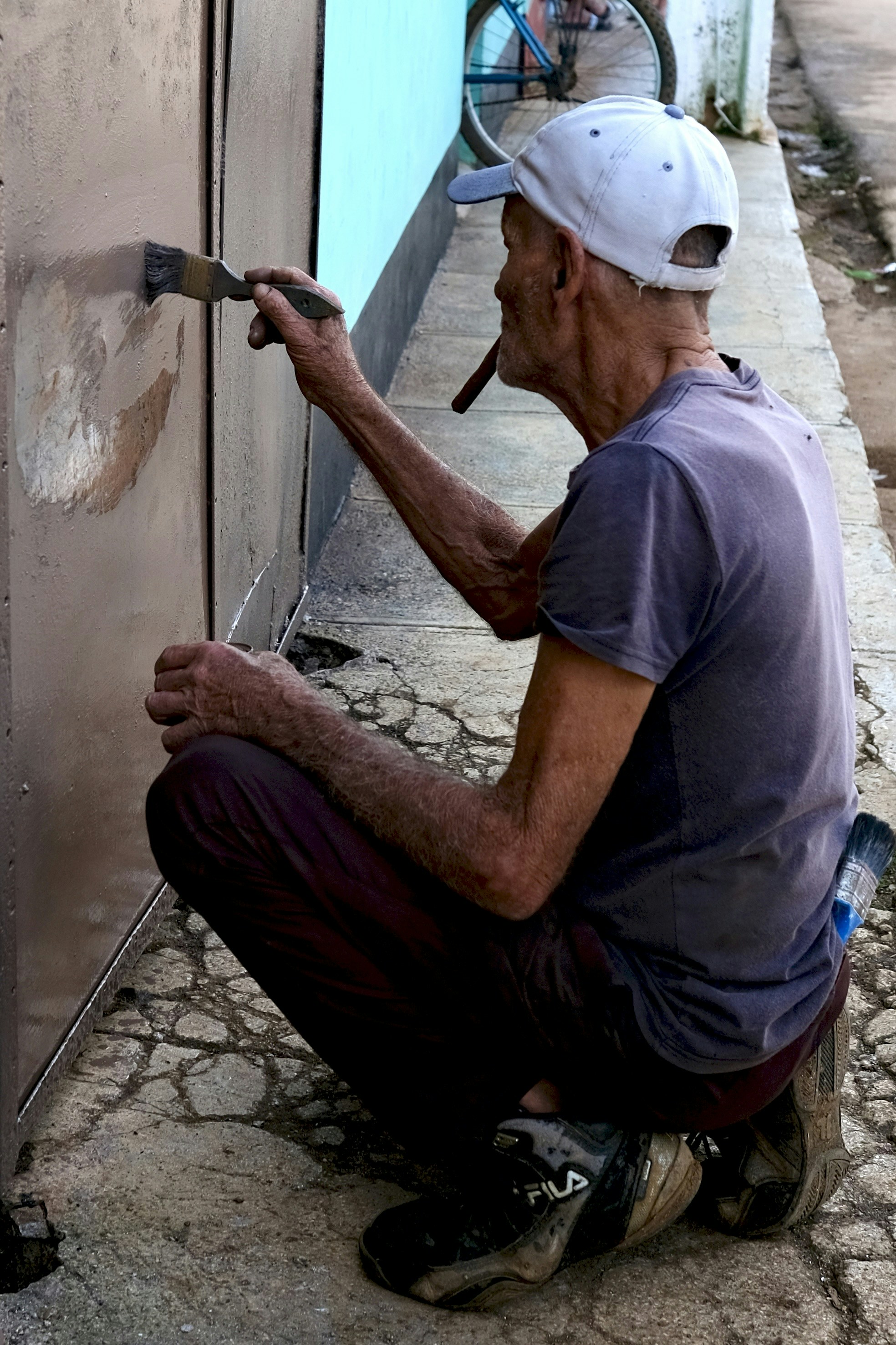 Brush and Boundary: A Painter’s Quiet Moment on the Street