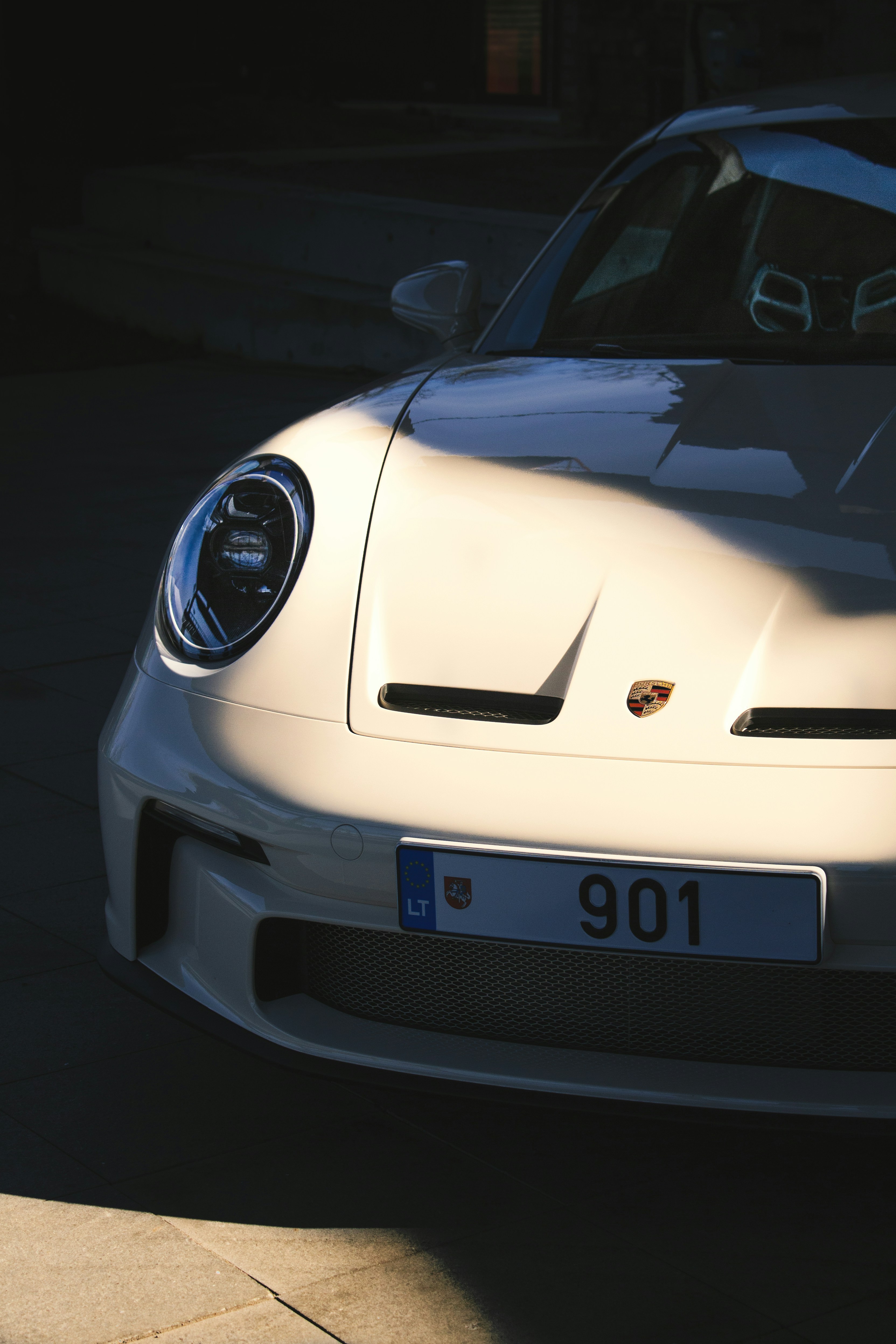 Chrome Curves: The Front-Quarter of a Porsche Bathed in Evening Light