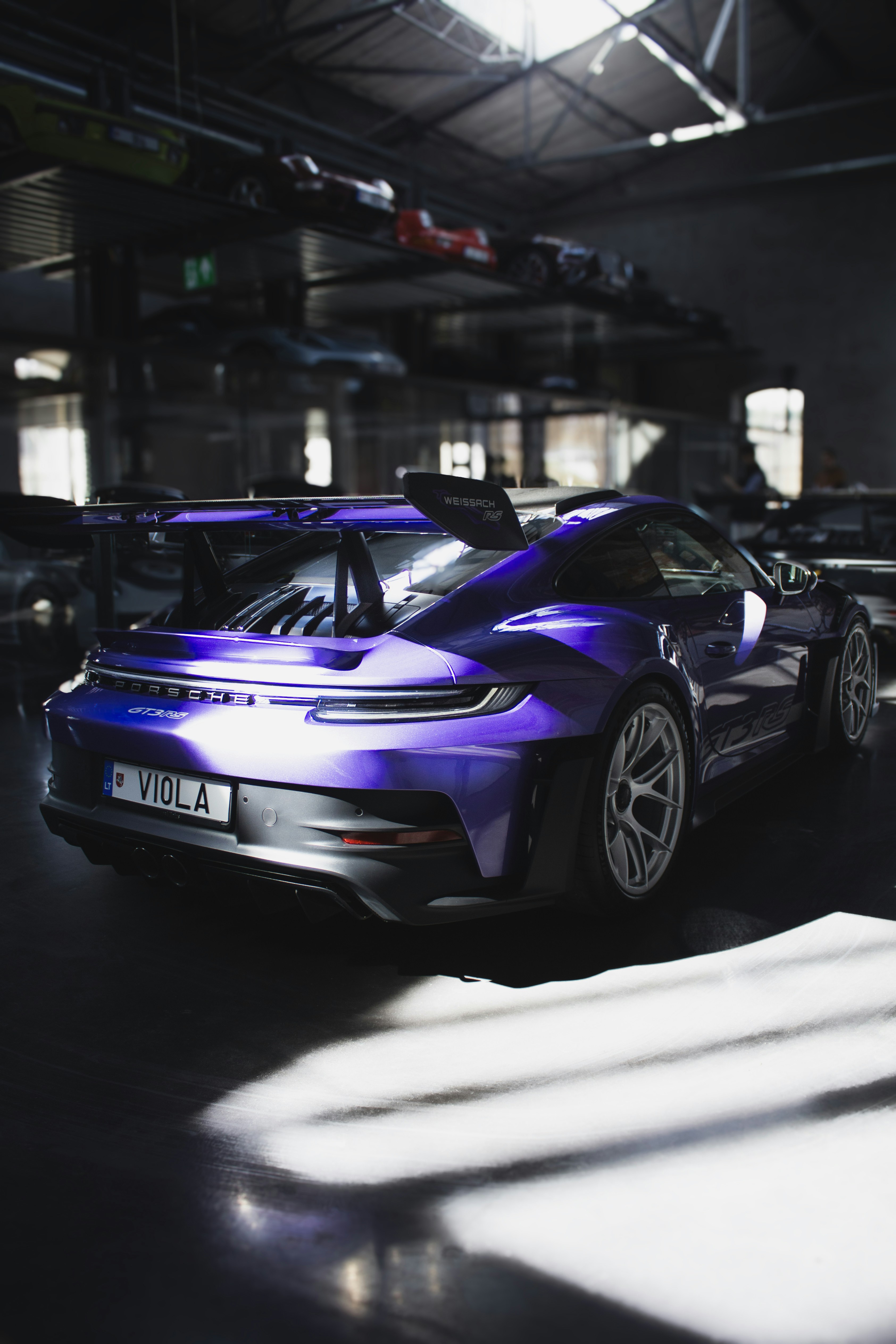 Midnight Violet: Porsche 911 GT3RS in a Sunlit Factory Quiet